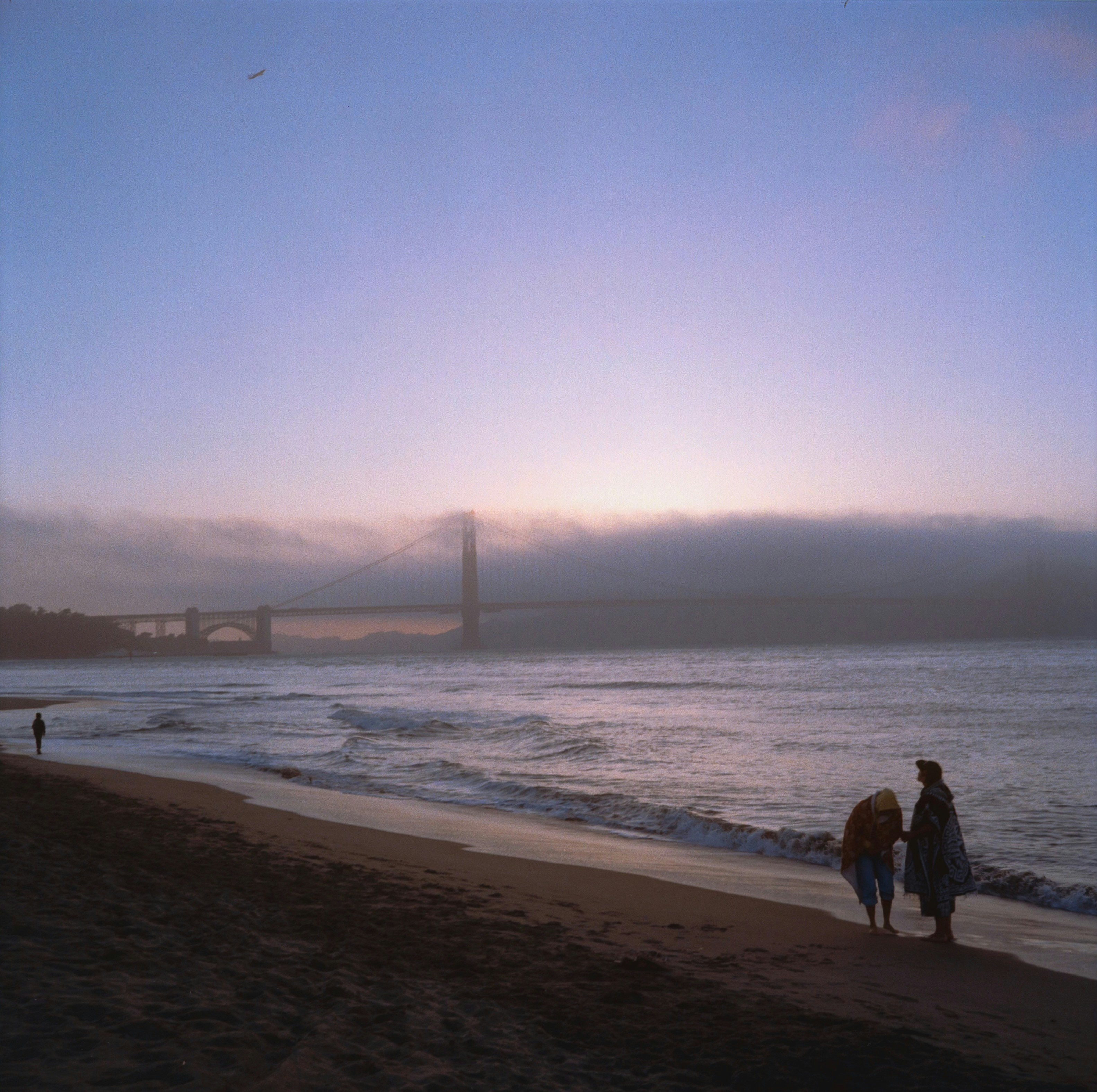 Dusk at the Suspended Horizon: Bridge, Beach, and Gentle Light