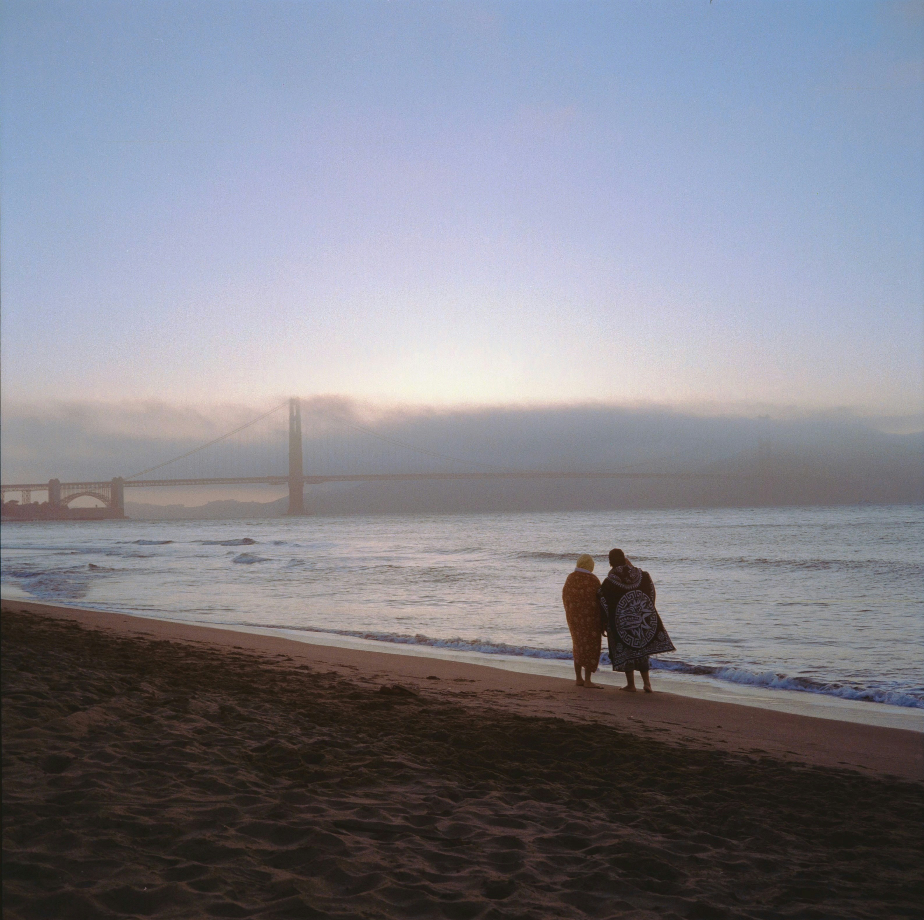 Dawn at the Pier: Two Figures on a Quiet Shore