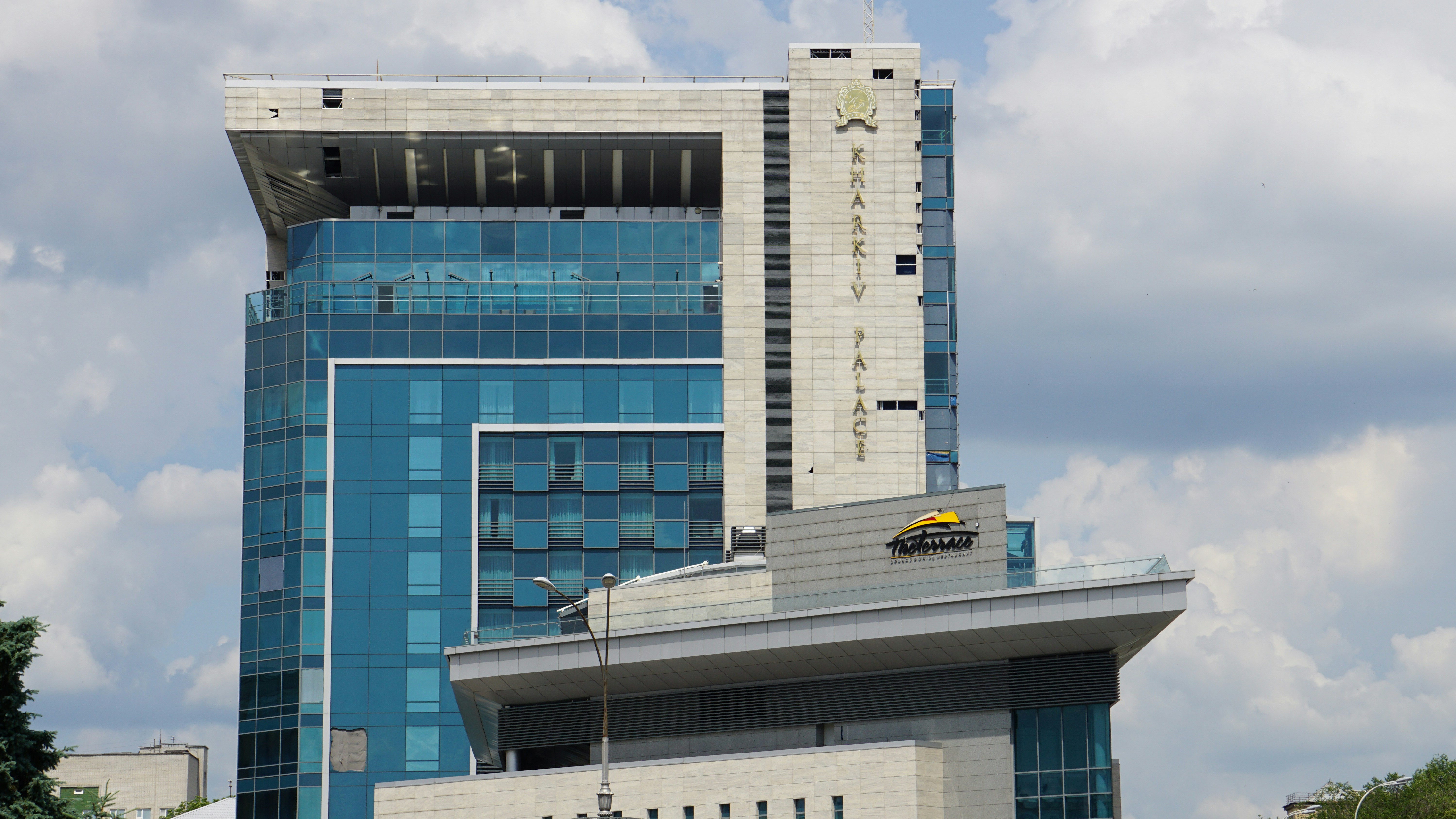 Azure Glass Tower Surges over a Geometric Cityscape