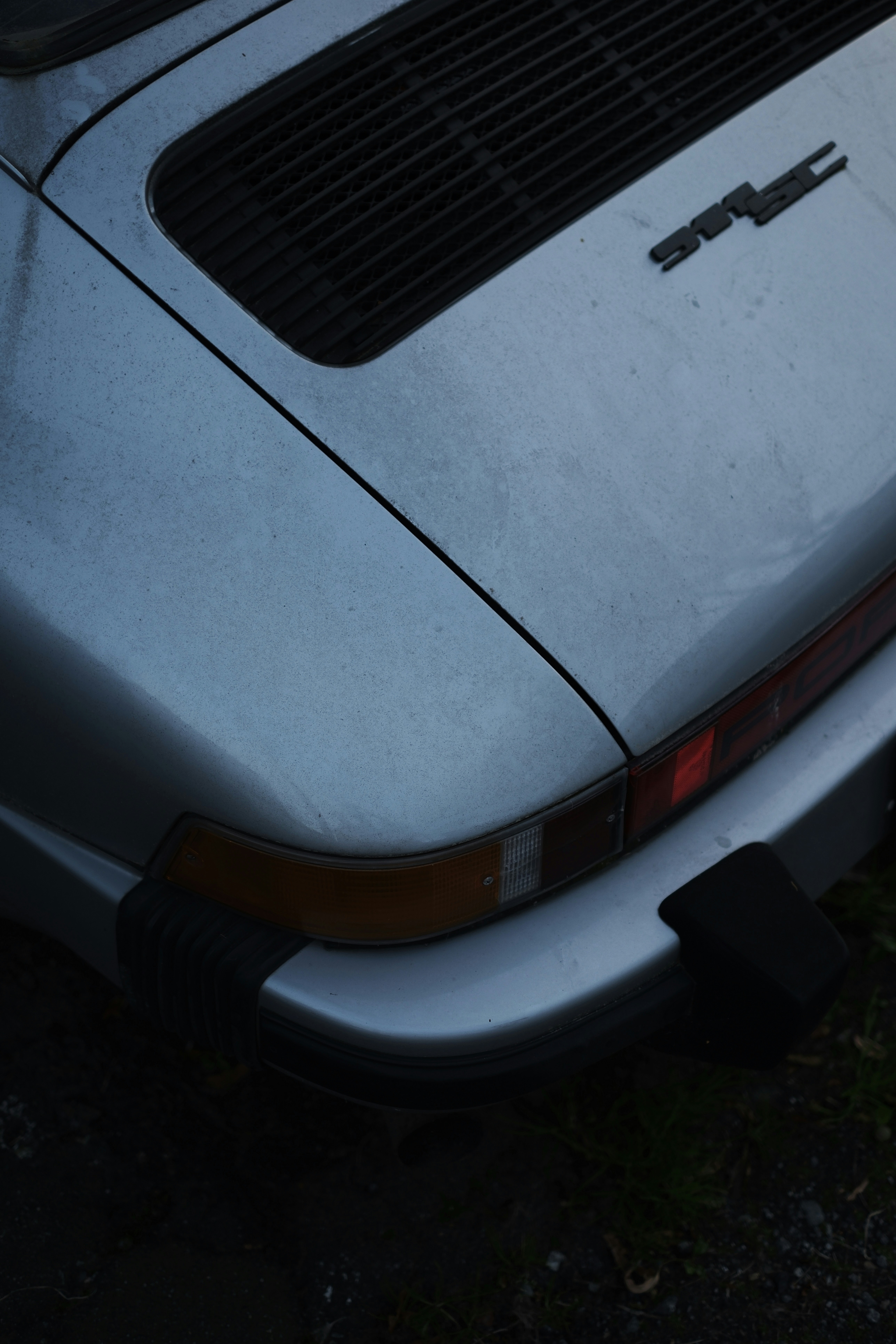 Azure Vintage Rear: a weathered badge gleams on a quiet hatch