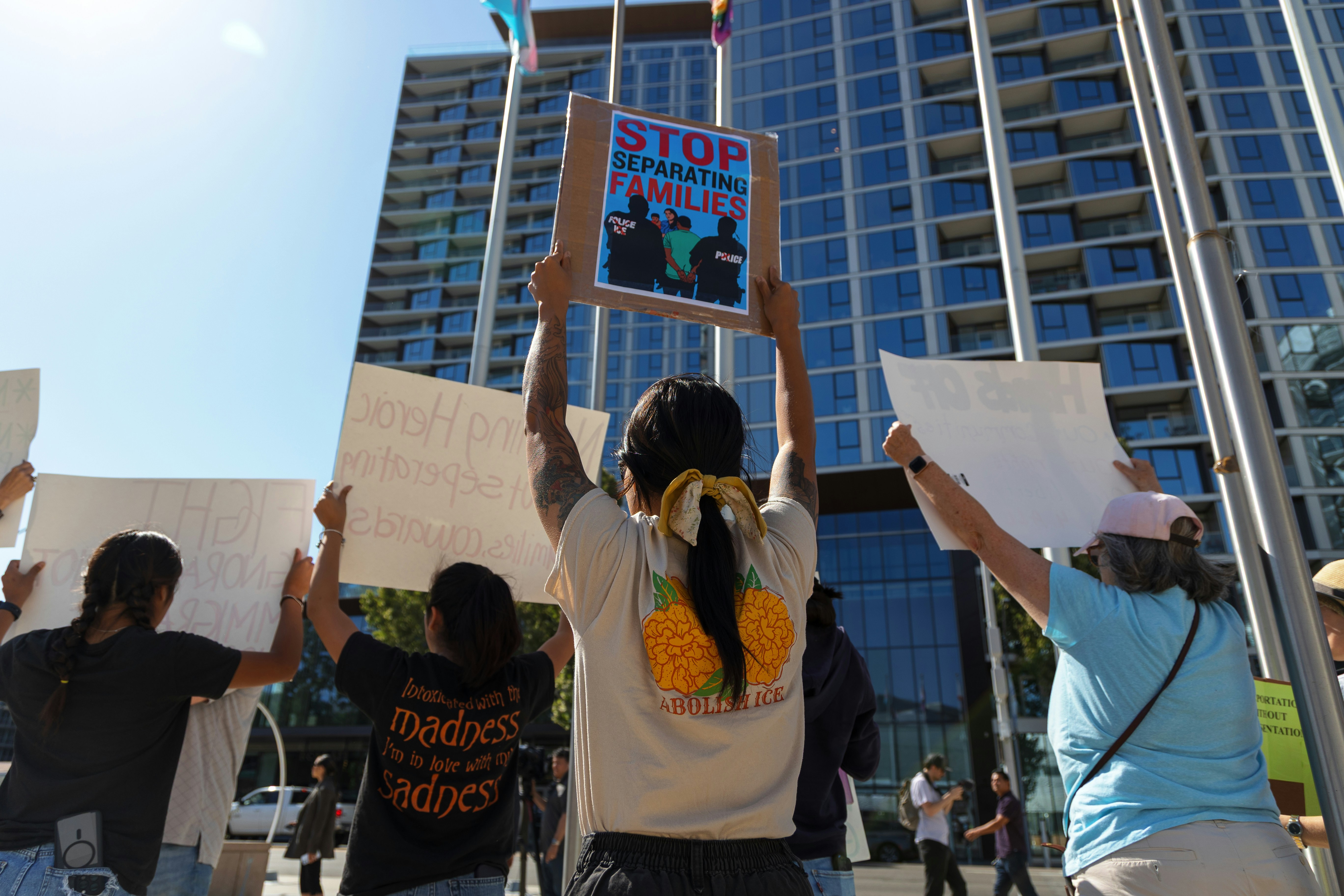 People protest, holding signs in front of a building. photo – Free Ice ...