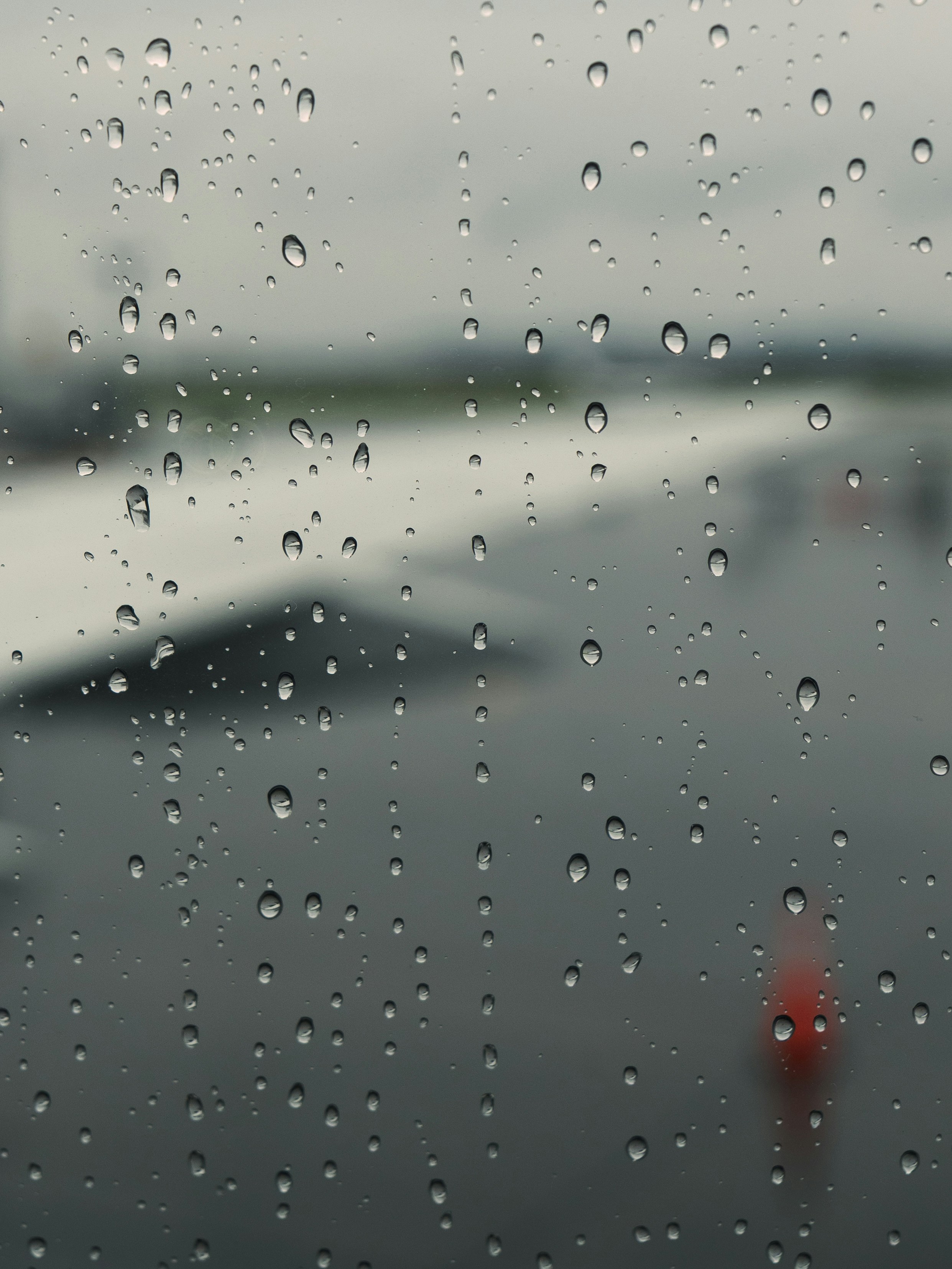 Raindrops on the Window: A Journey's Pause