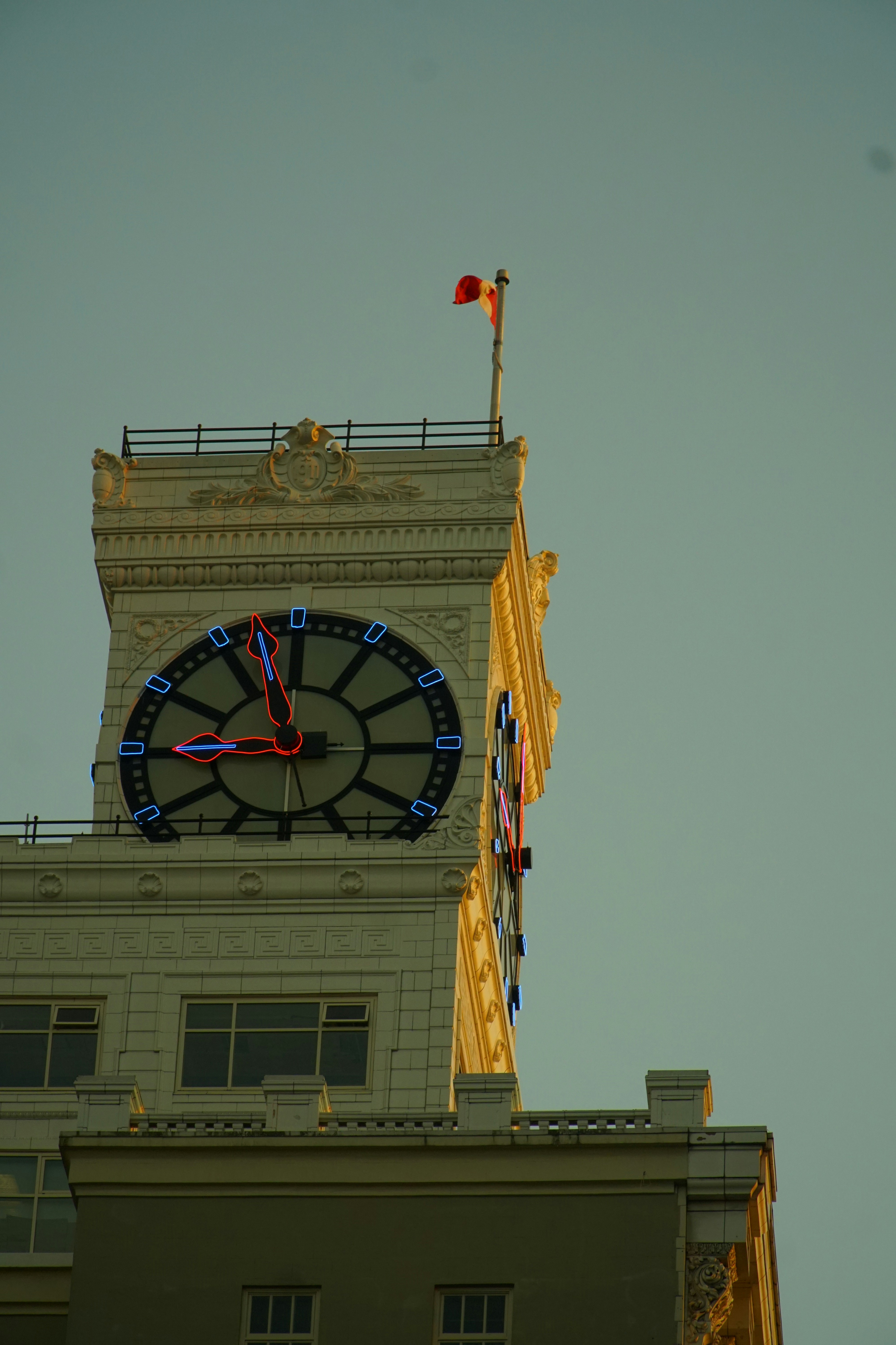 Neon-Blue Time Ring on an Ornate Clock Tower
