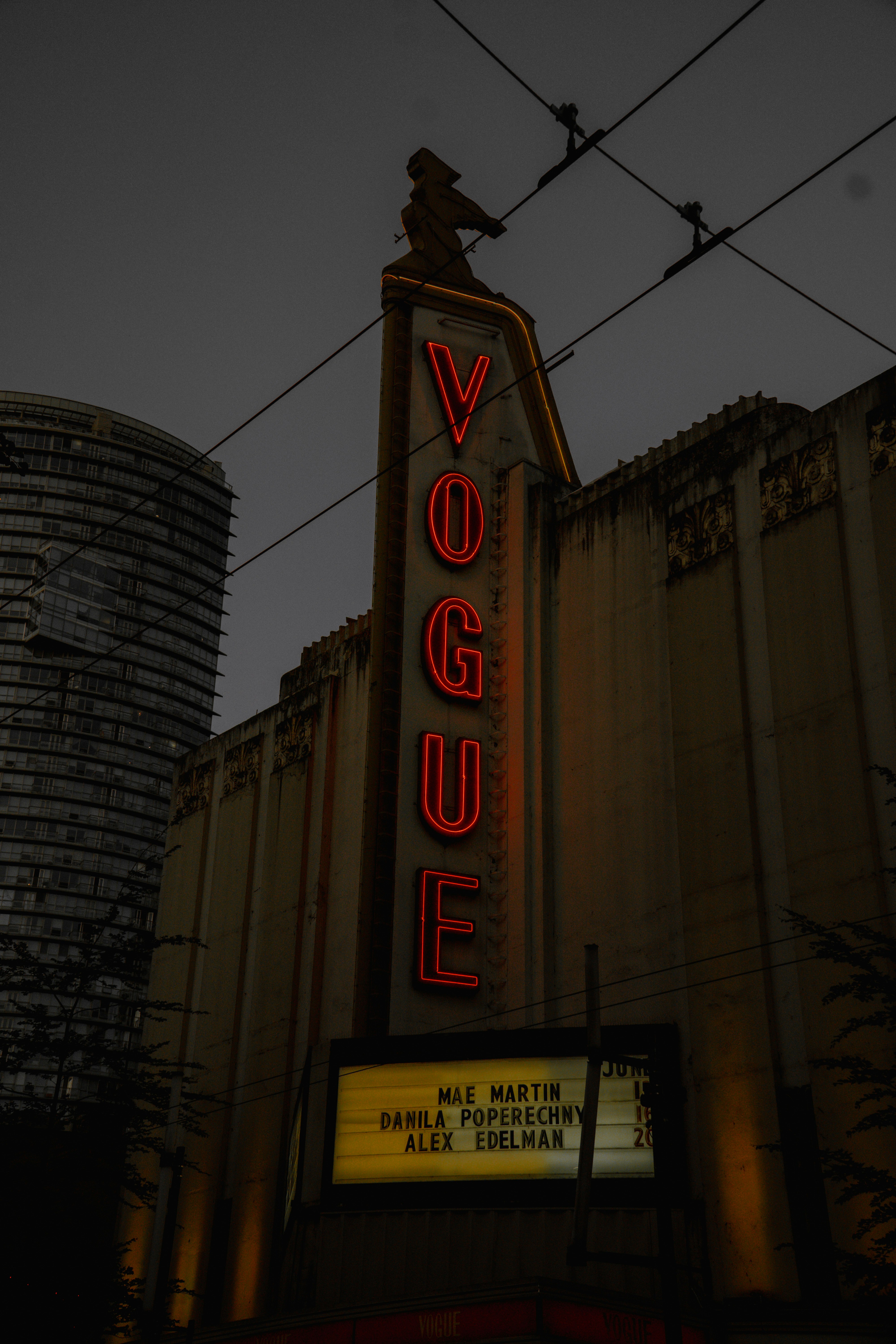 The vogue theatre's neon sign glows in the night. photo – Free City ...