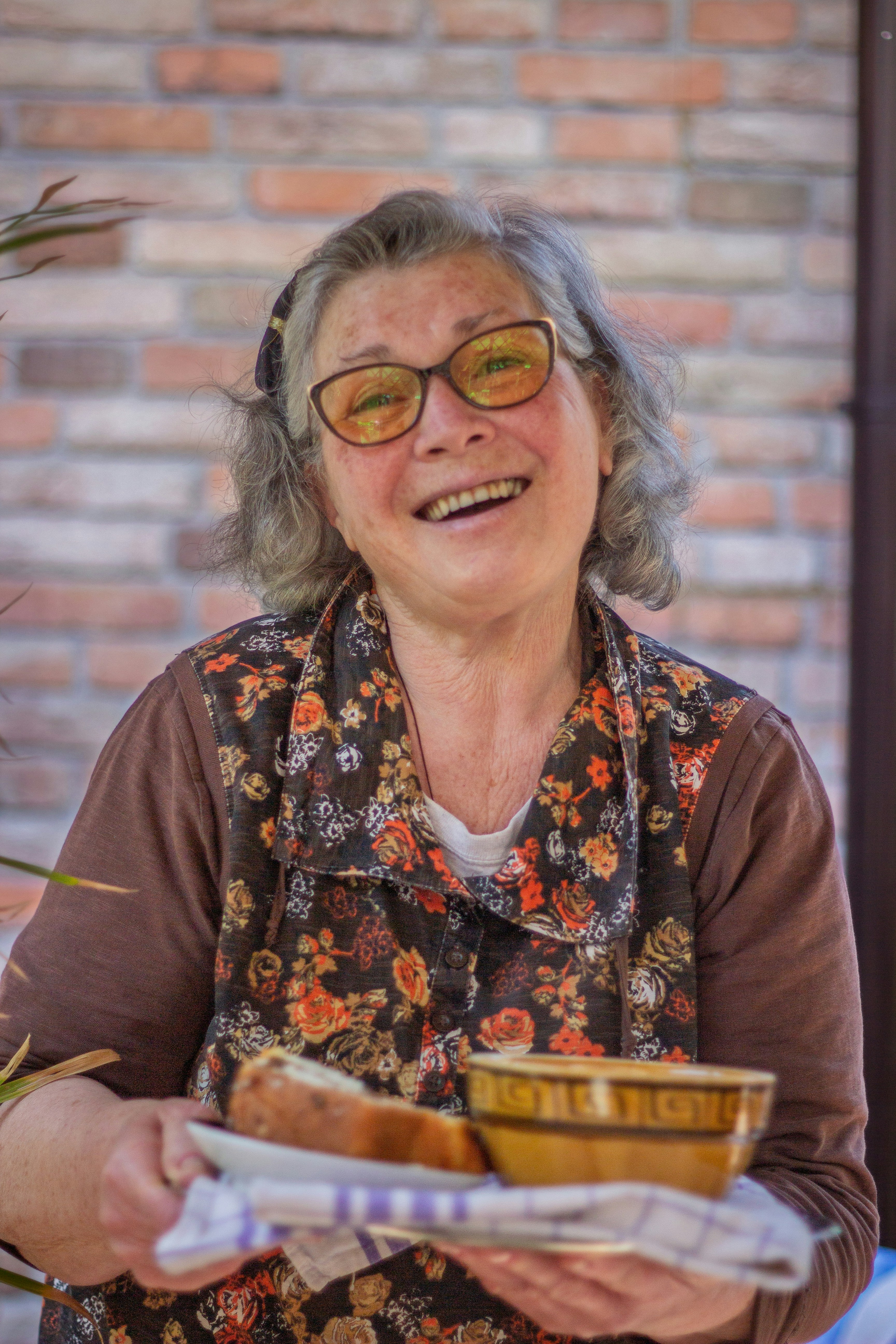 Sunlit Porch Portrait: A Warm Smile with Floral Shawl and Bread