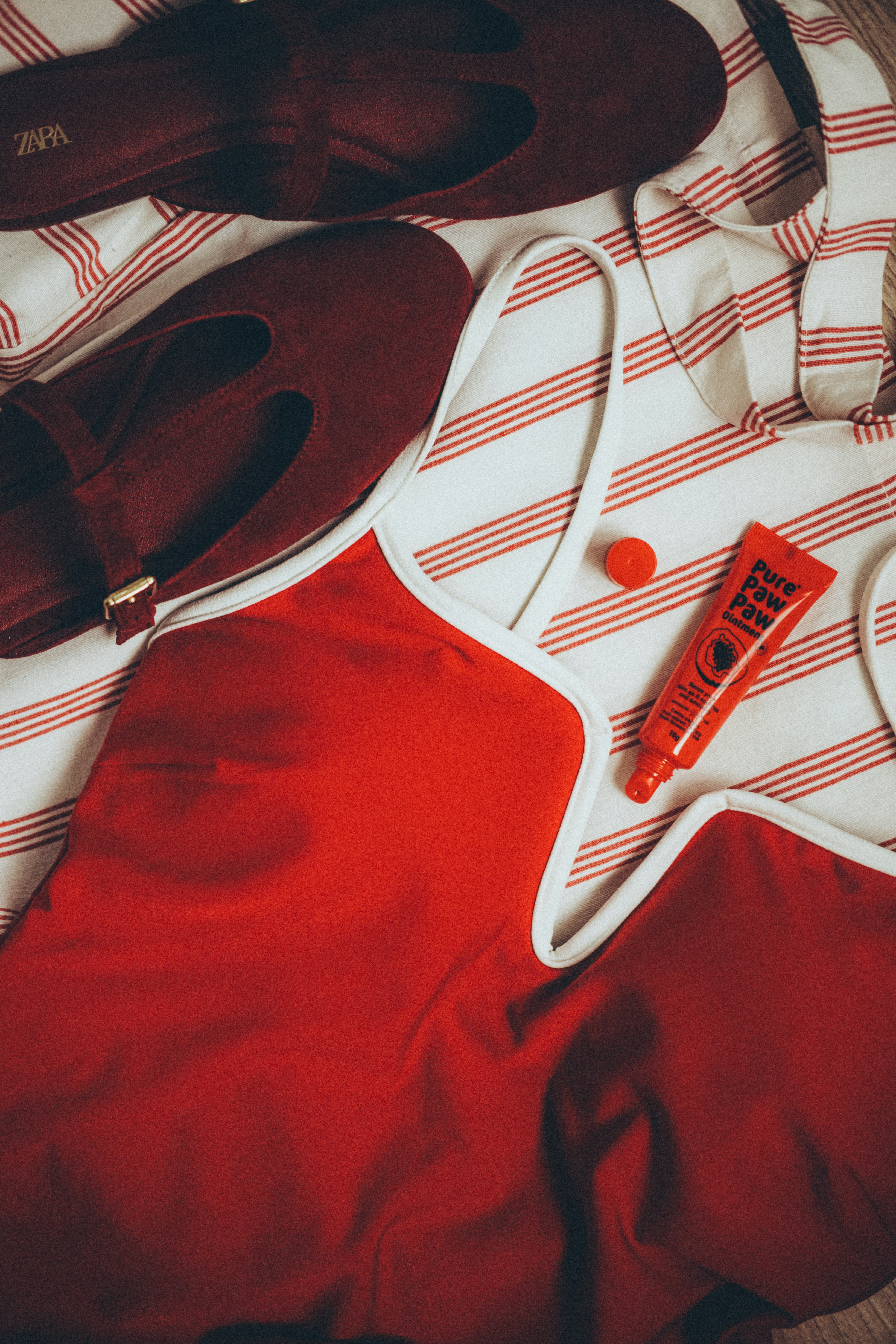 Red clothing and accessories are artfully arranged.