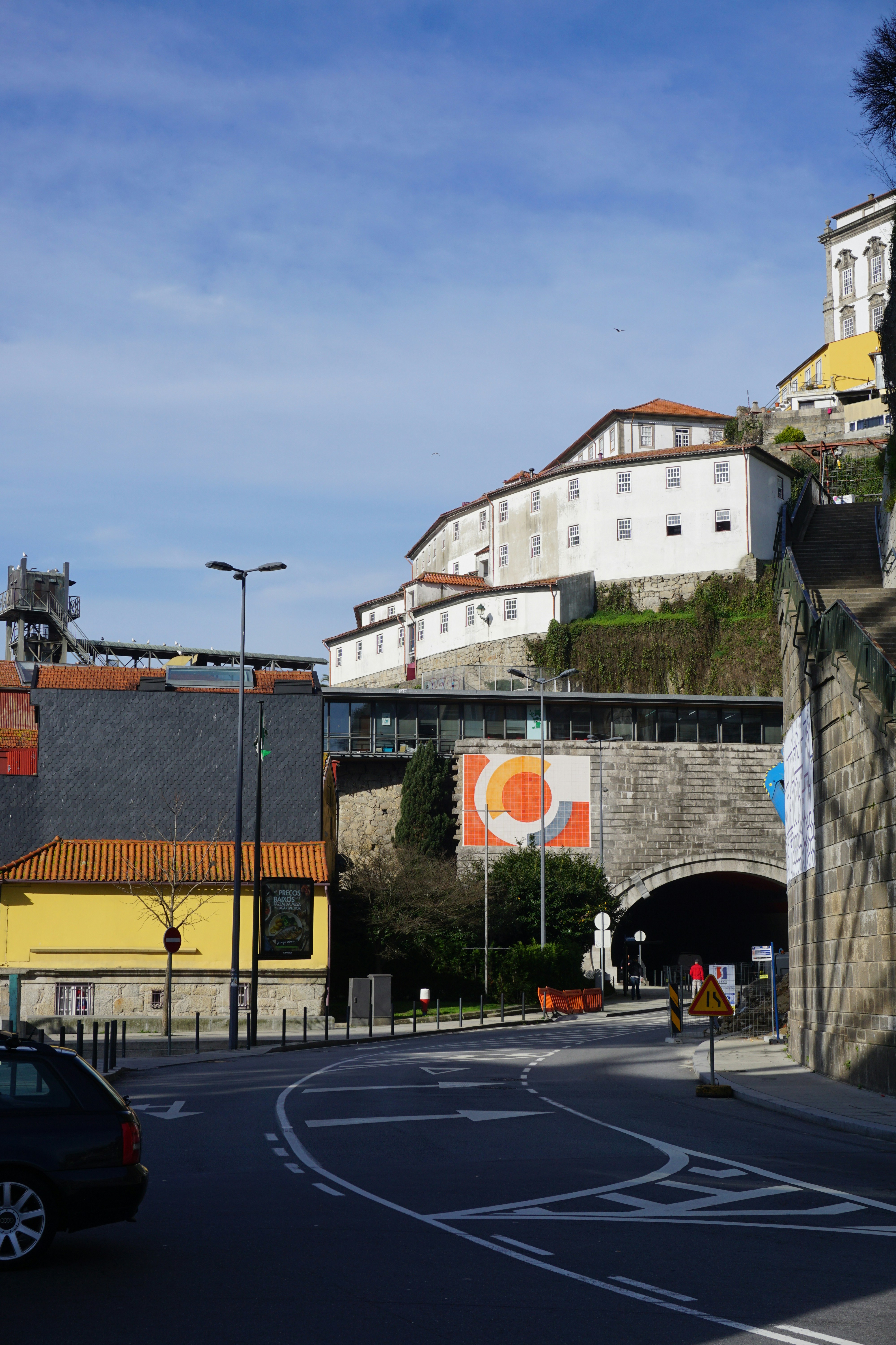 Orange Circle Mural by the Tunnel: A Hillside Street Portrait