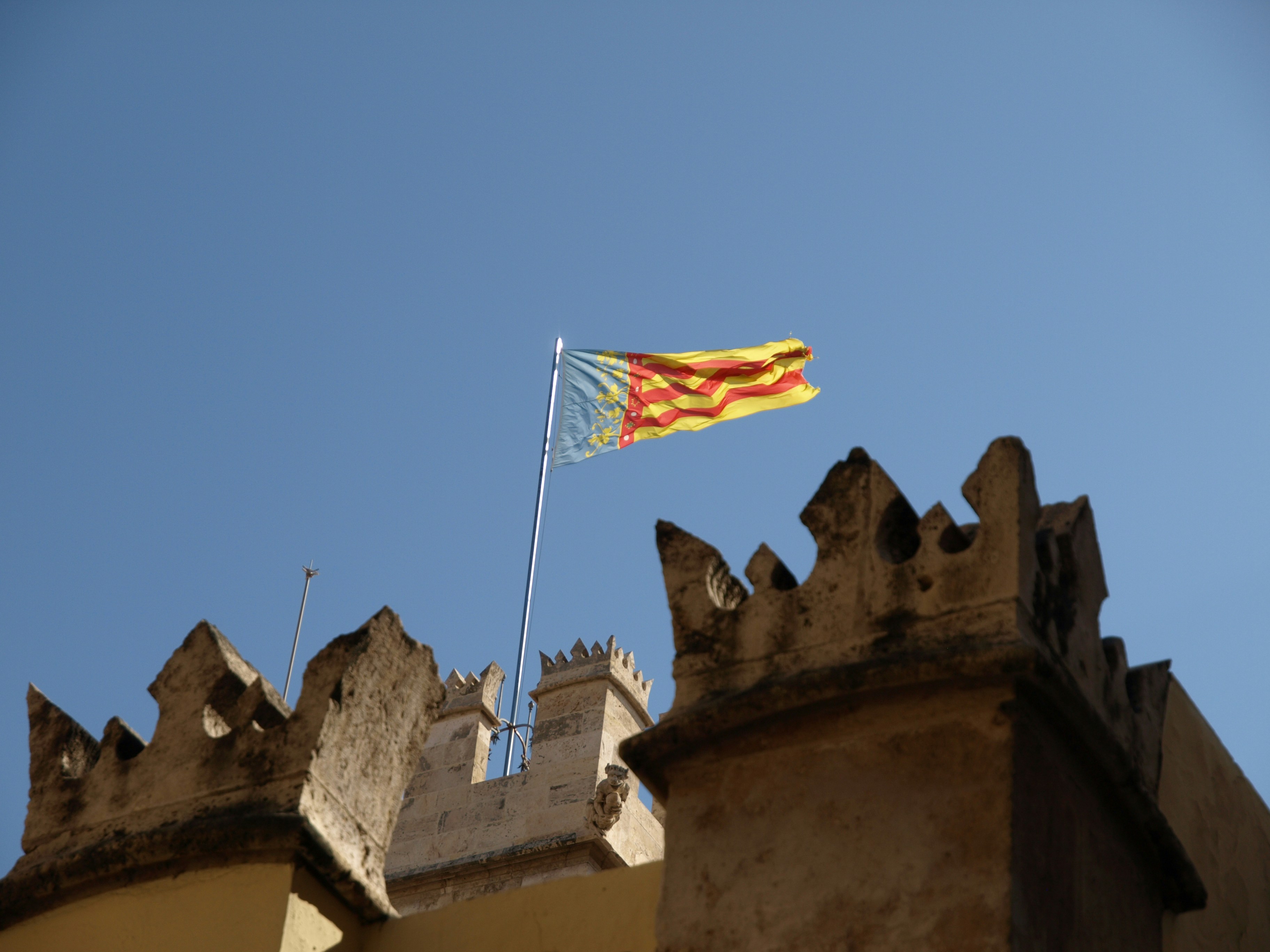 A flag flies above a stone castle.