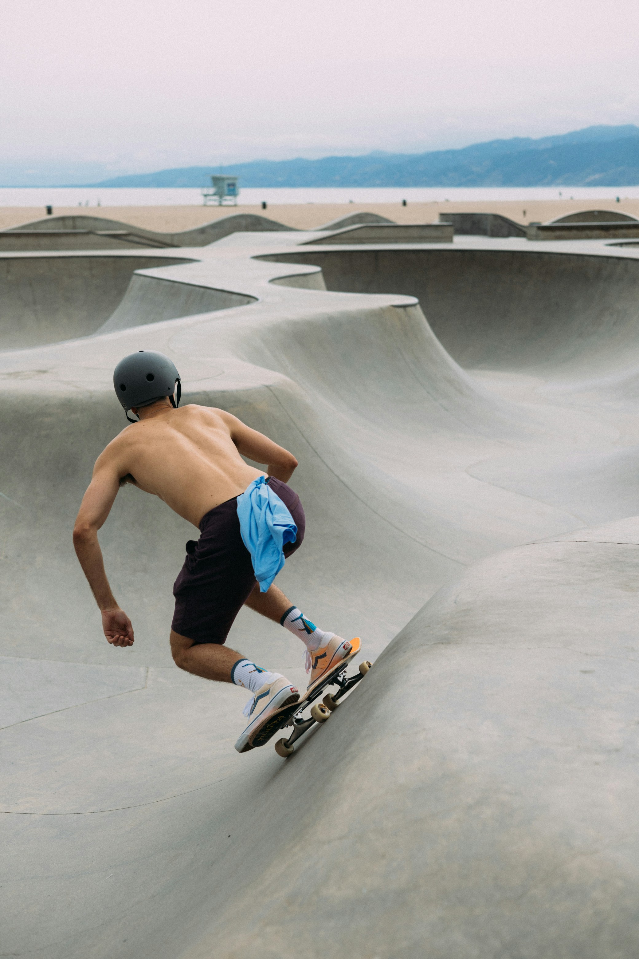 Skateboarder carving through a skate park. photo – Free Beach Image on ...