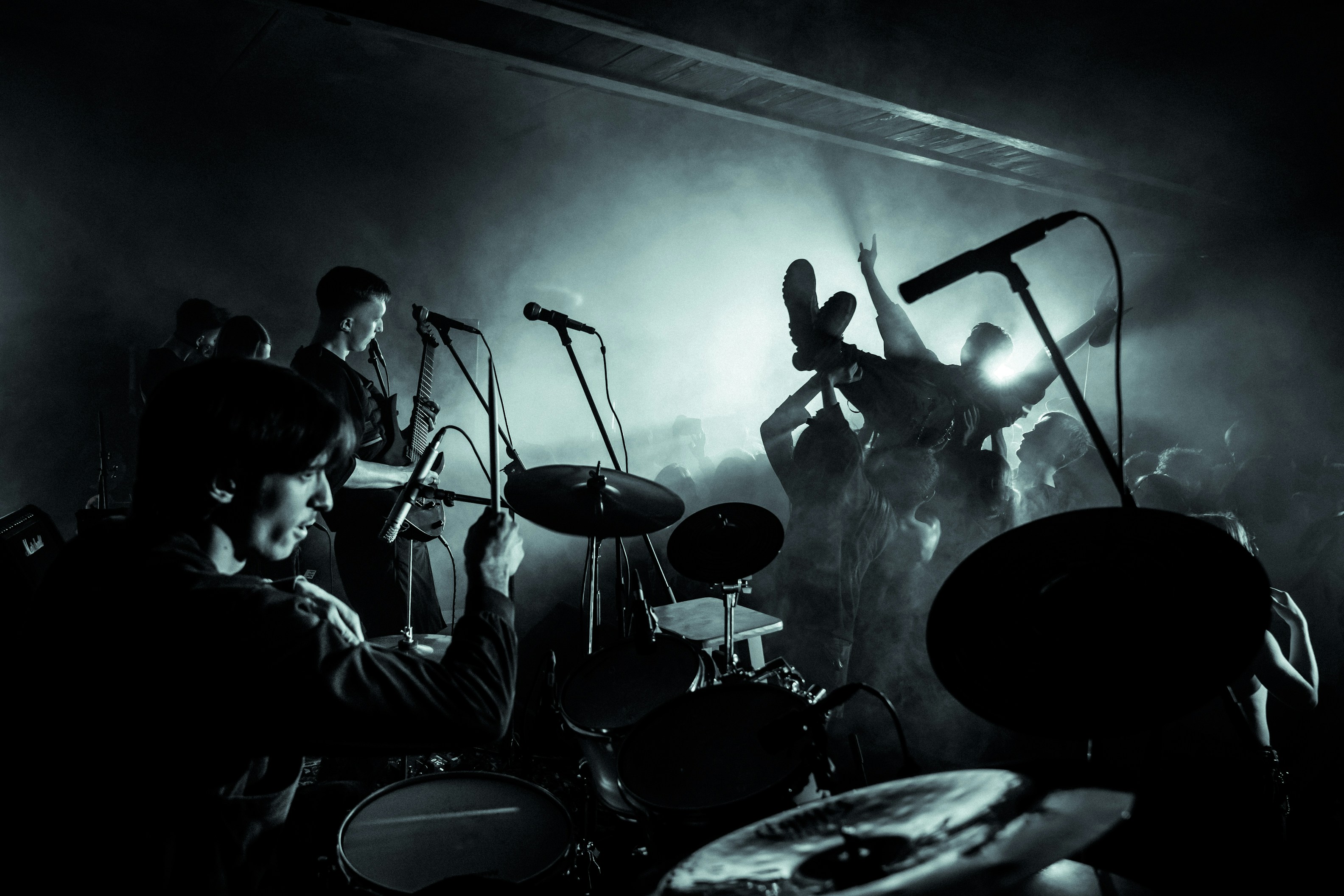 A band performs with a crowd and stage diving. photo – Free Concert ...