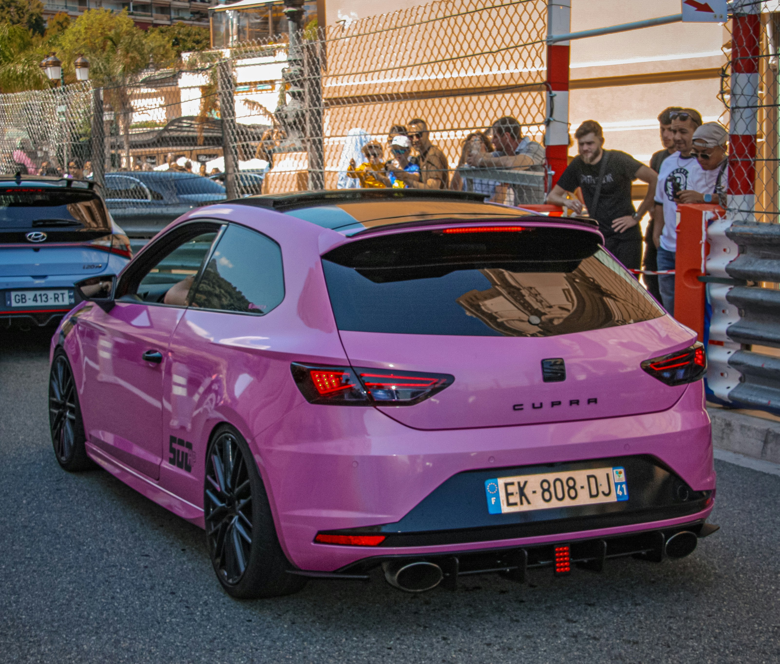 Pastel Power on a City Circuit: Pink Cupra Revs Behind the Fence
