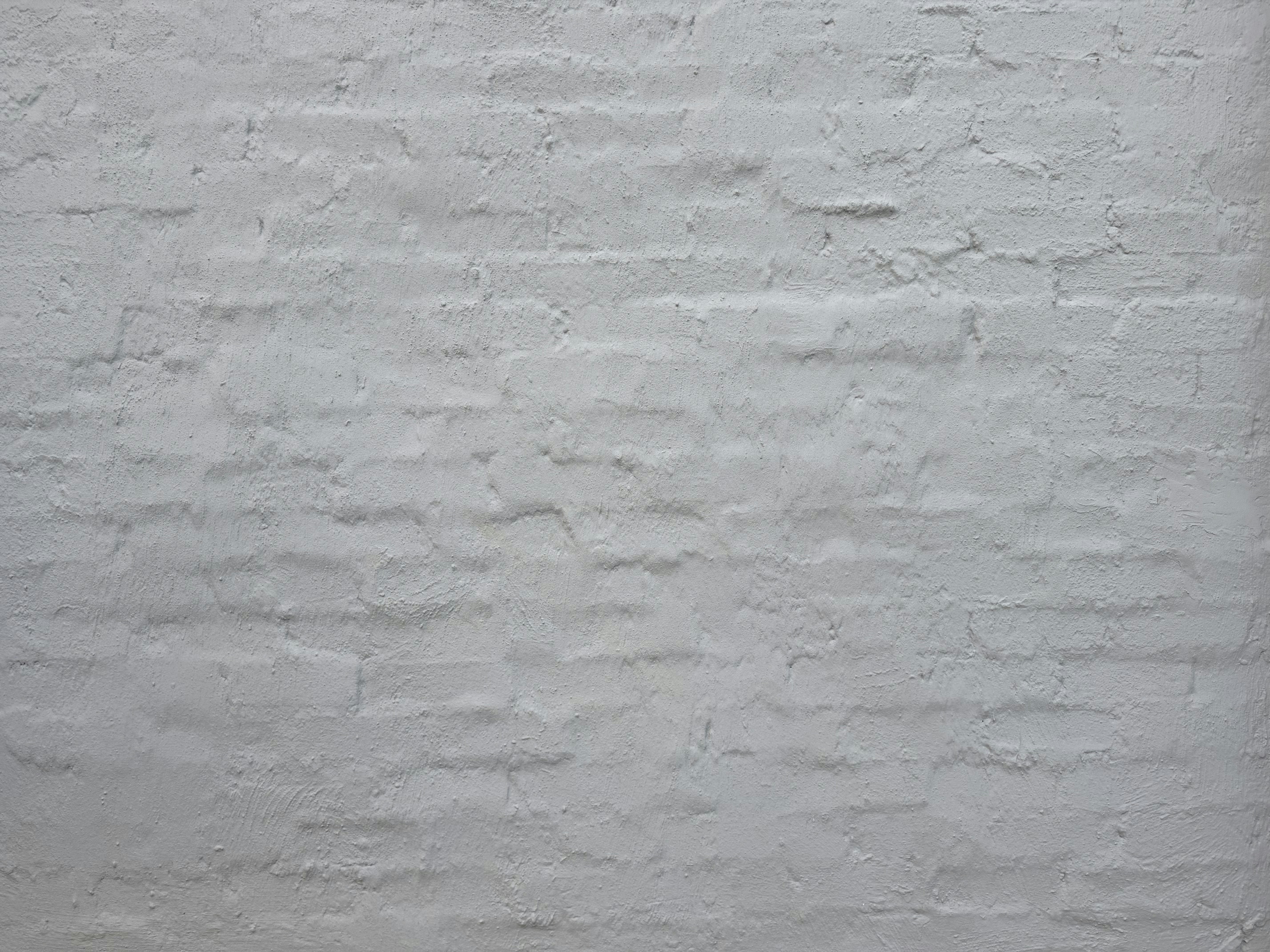 Brick textured wall painted | White-painted brick wall texture provides the image's focus.