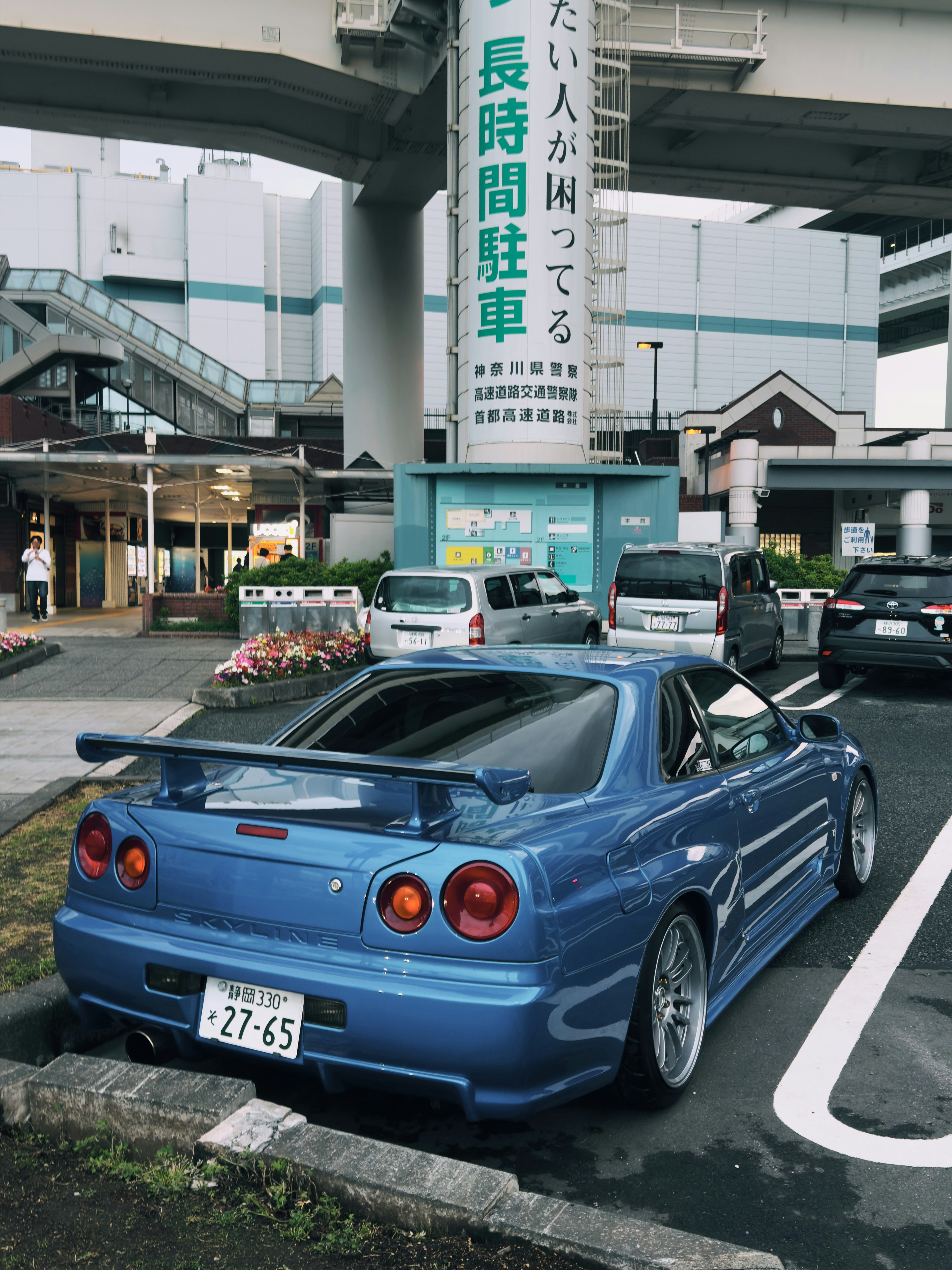 A blue nissan skyline r34 parked outdoors.
