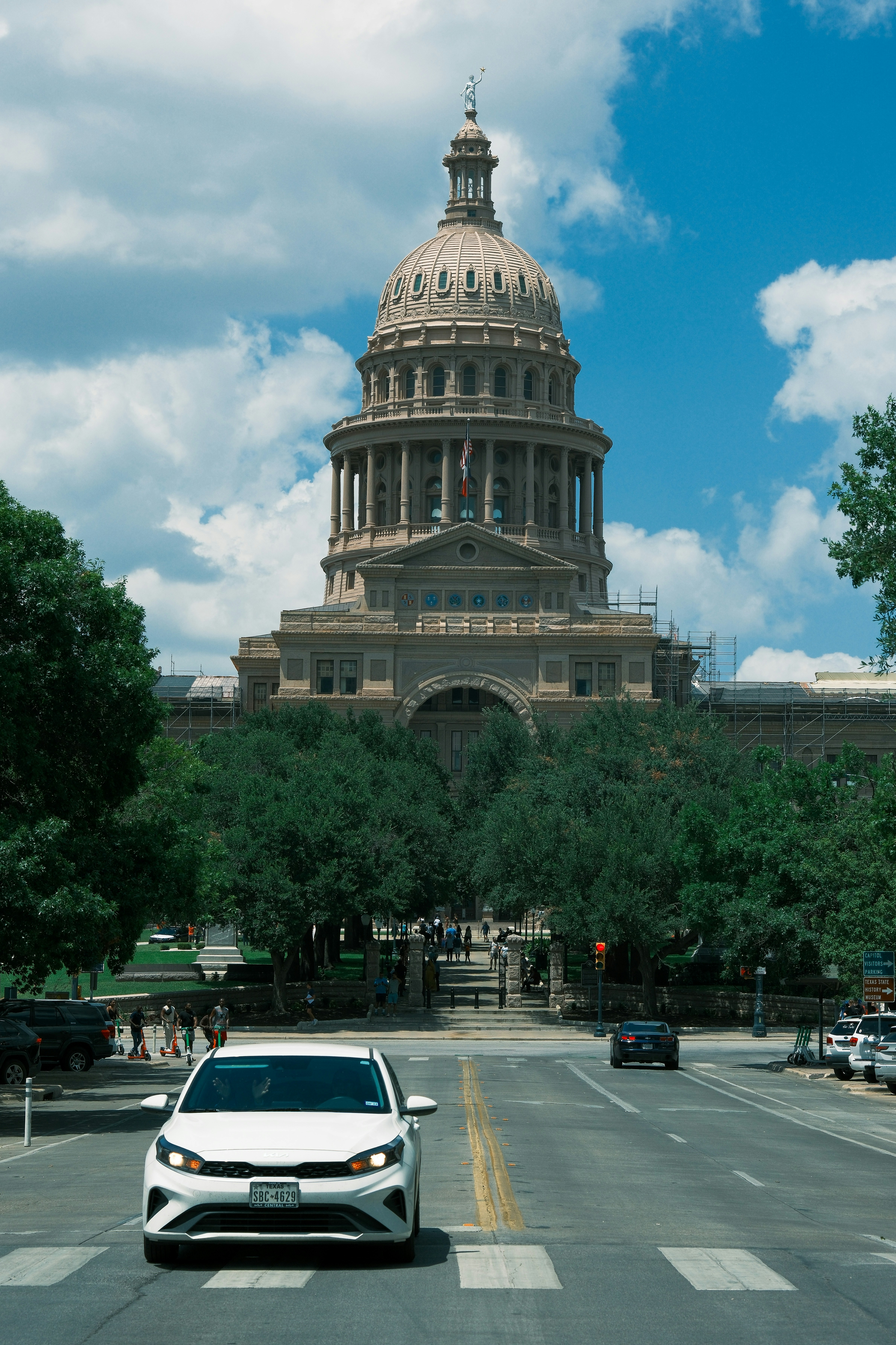The texas state capitol building with a car on the road. photo – Free ...