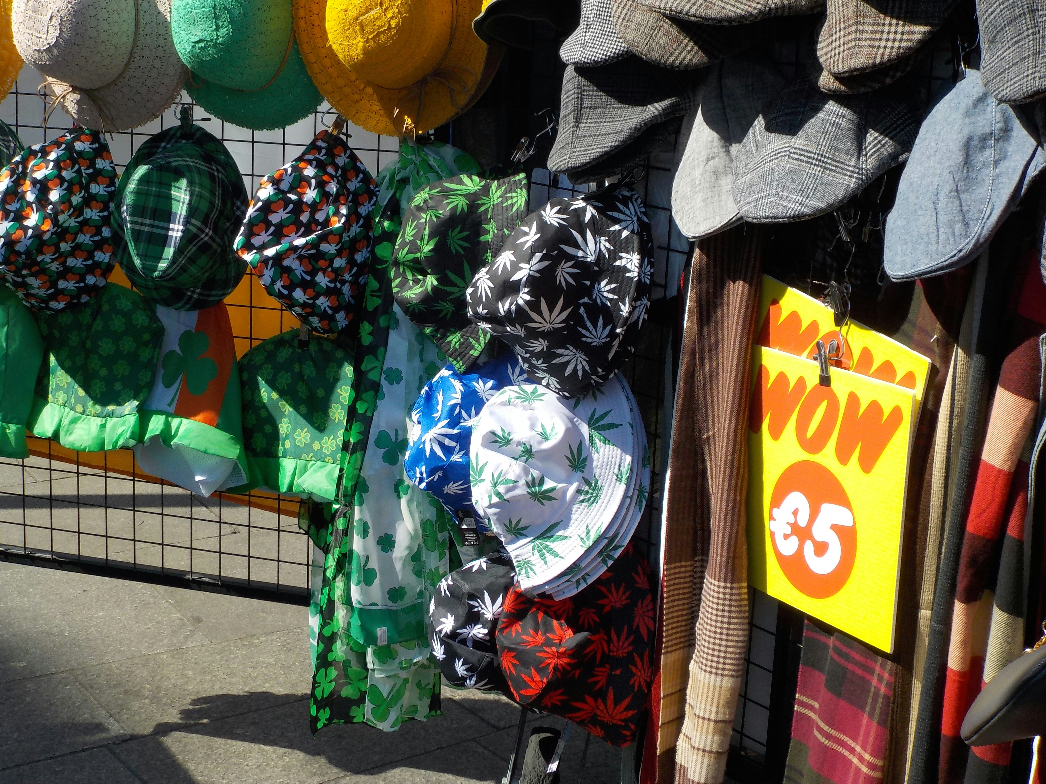 Hats and scarves for sale at a market.