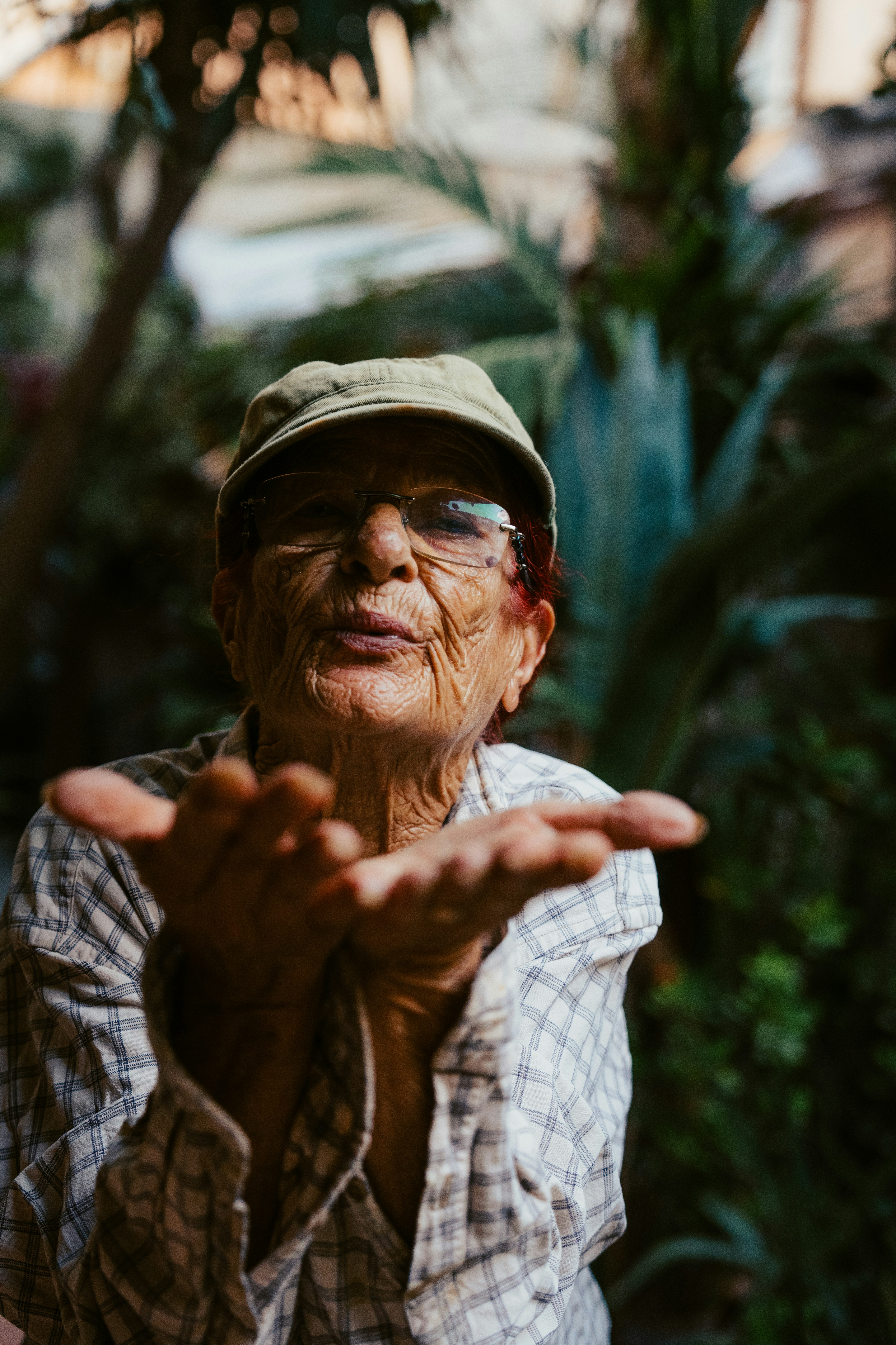 An elderly woman sends a kiss.