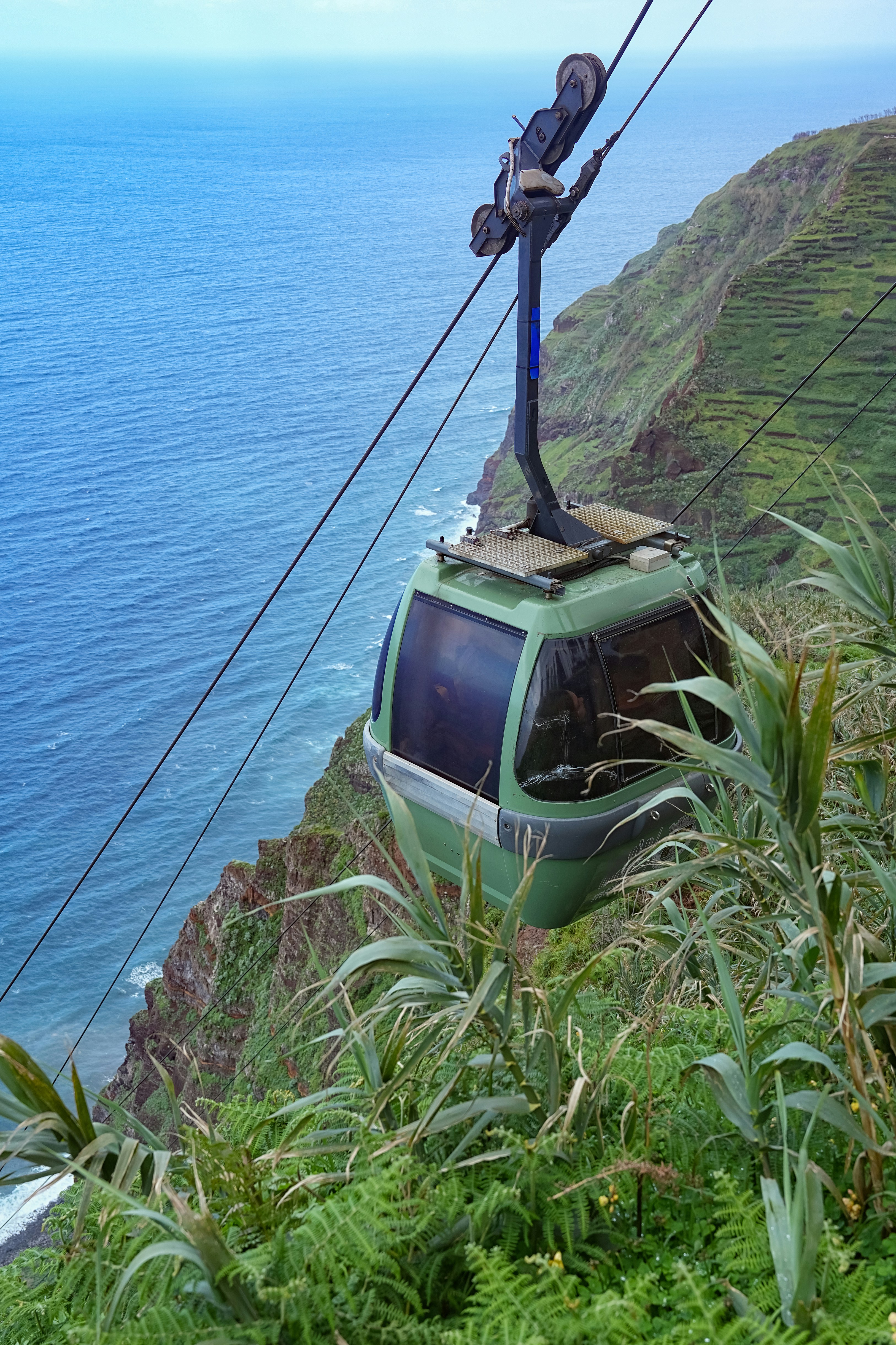 Verdant Cliffline Glide: a Green Cable Car Across the Pacific