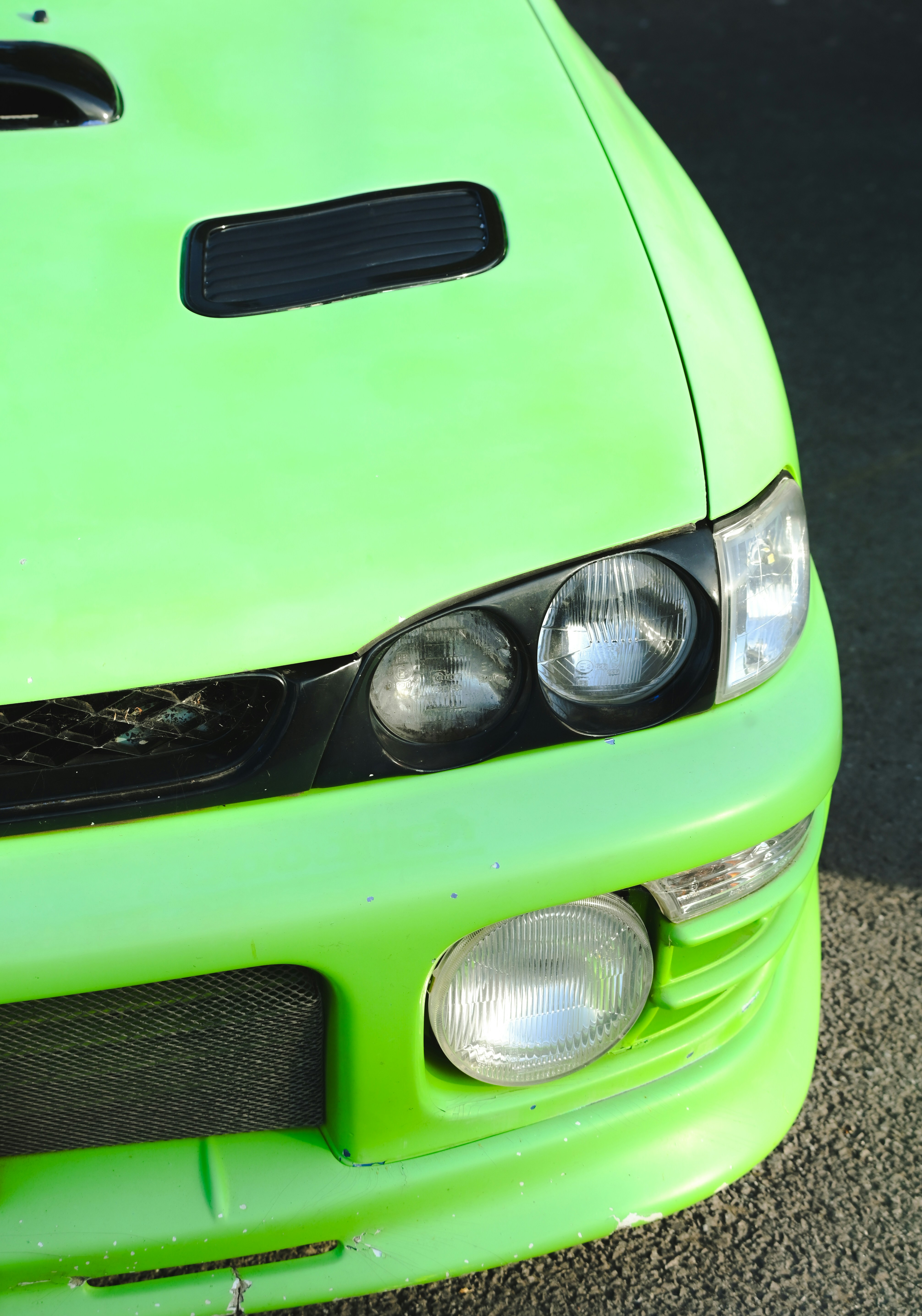 Emerald Front: Precision Lines and Twin Headlights on a Neon Green Street Machine