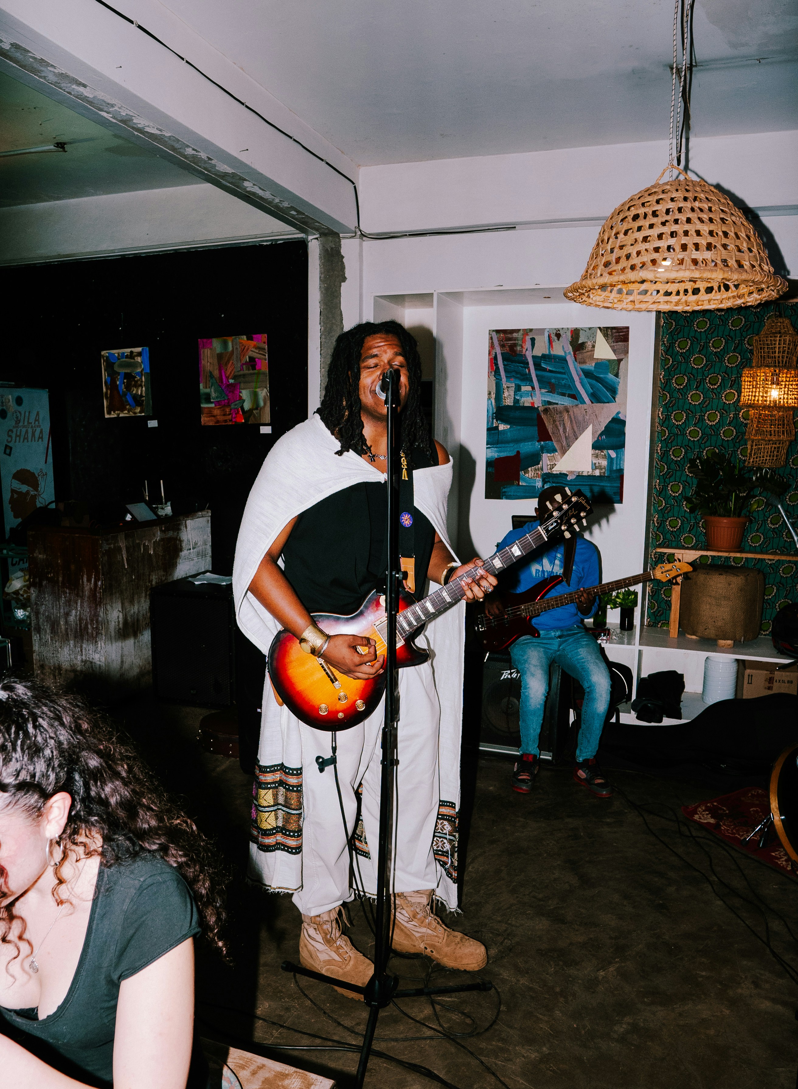 A musician performs on stage at an indoor concert. photo – Free Guitar ...
