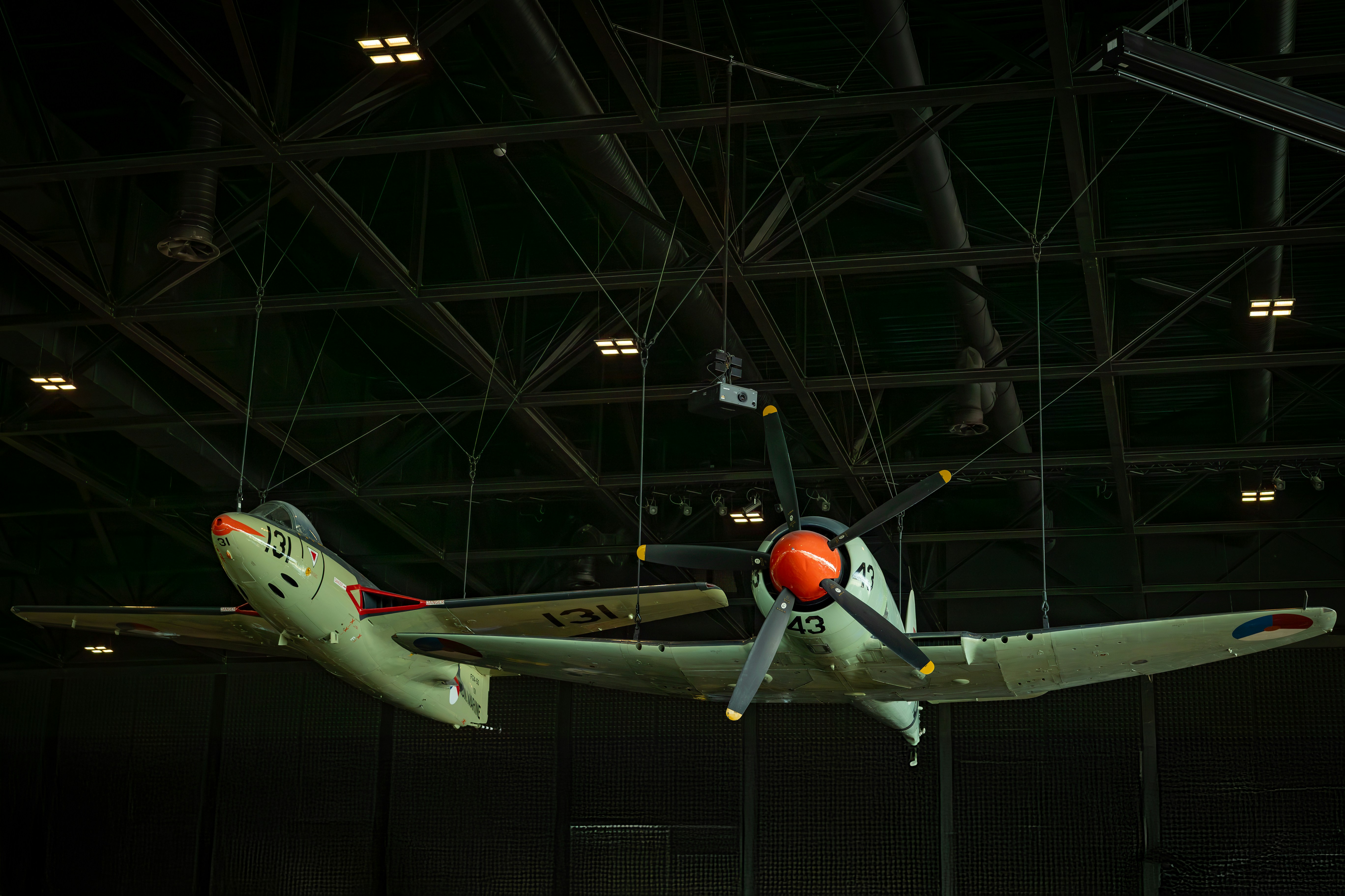 Two fighter planes are suspended from the ceiling. photo – Free ...