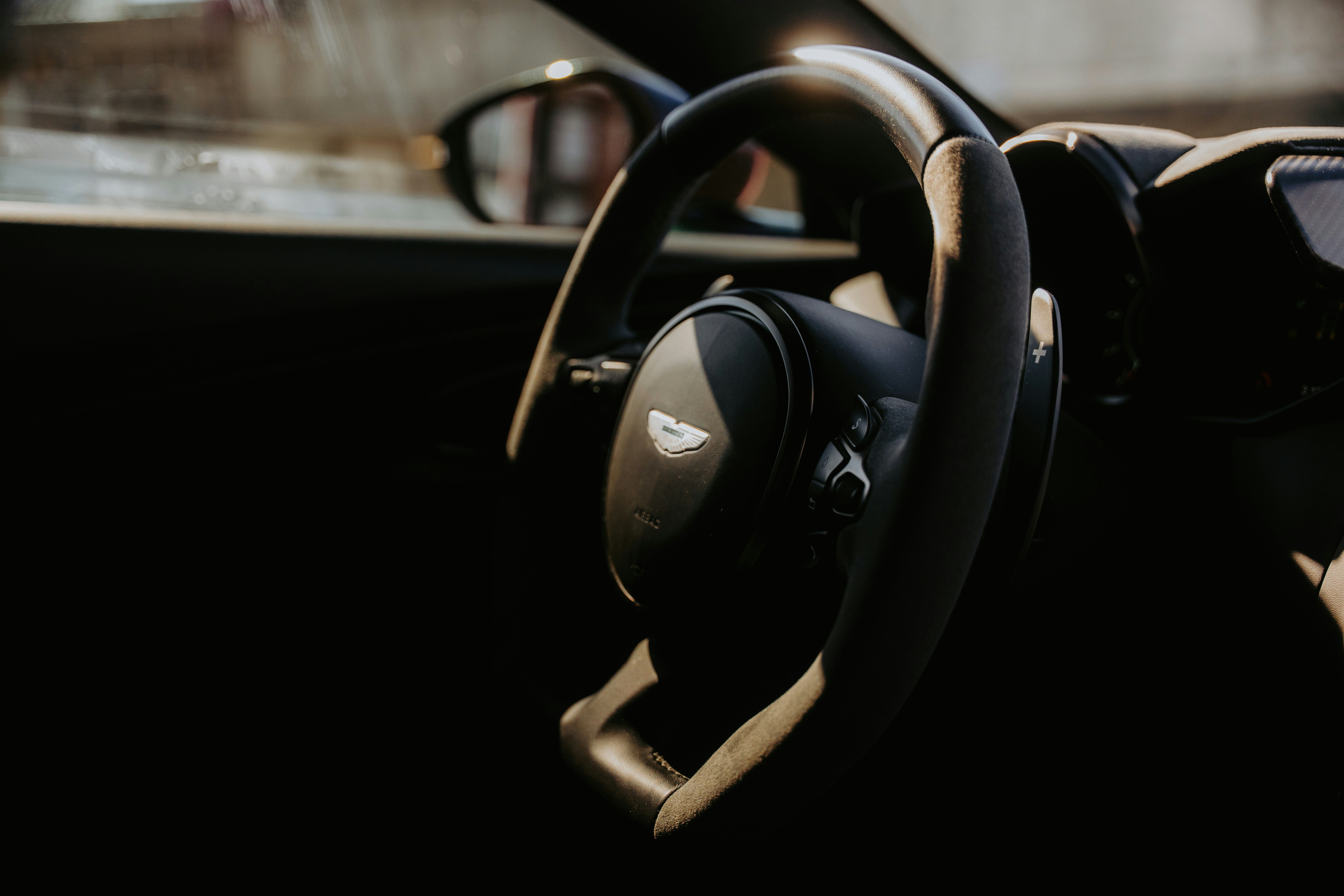 Aston martin's steering wheel, close up.