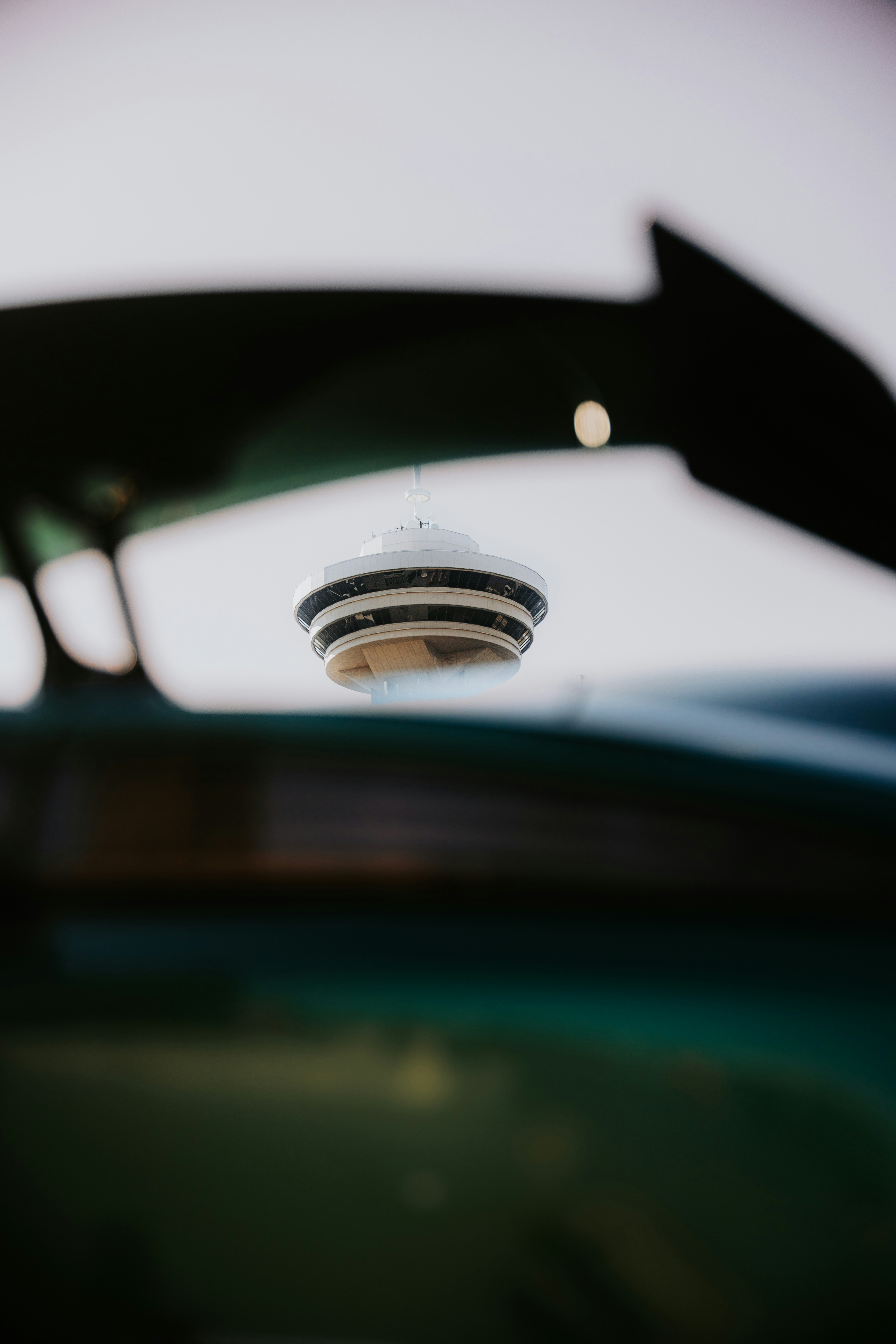 A Hidden Skyline: Tower Peeking Through a Car Window