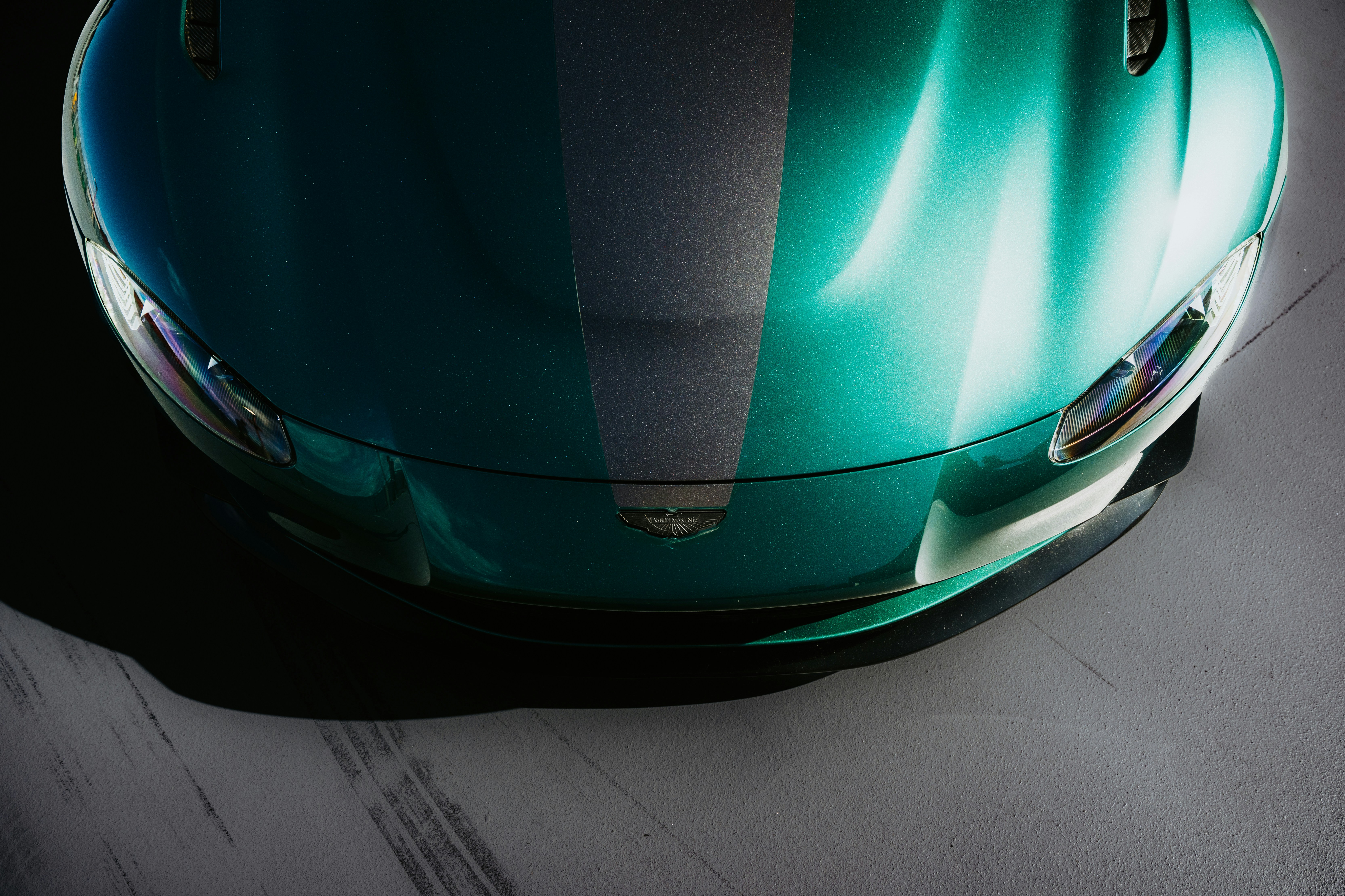 Verdant Velocity: Aerial Close-Up of a Metallic Green Sports Car Front