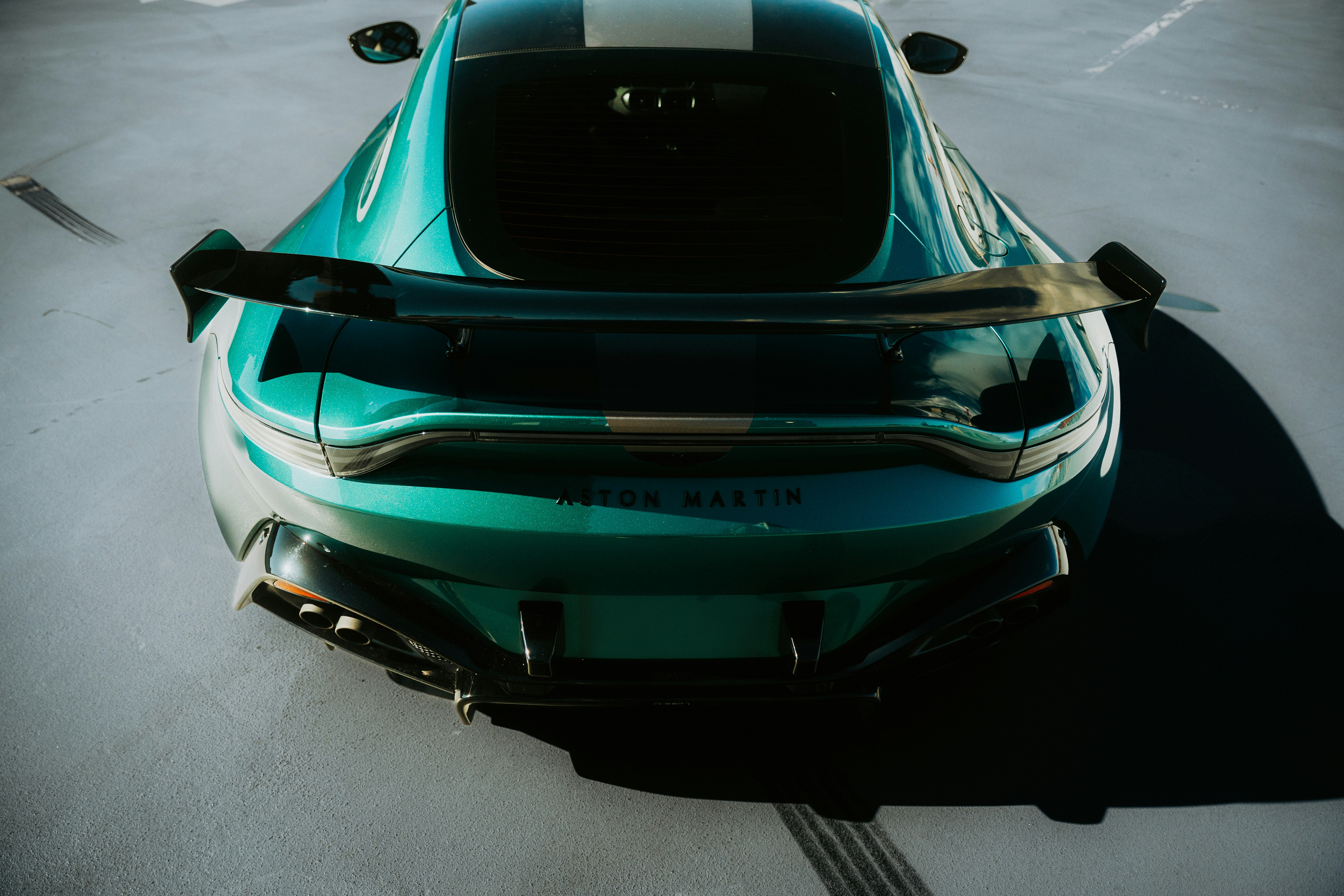 Teal Winged Contour: A Rear Portrait of a Winged Sports Car