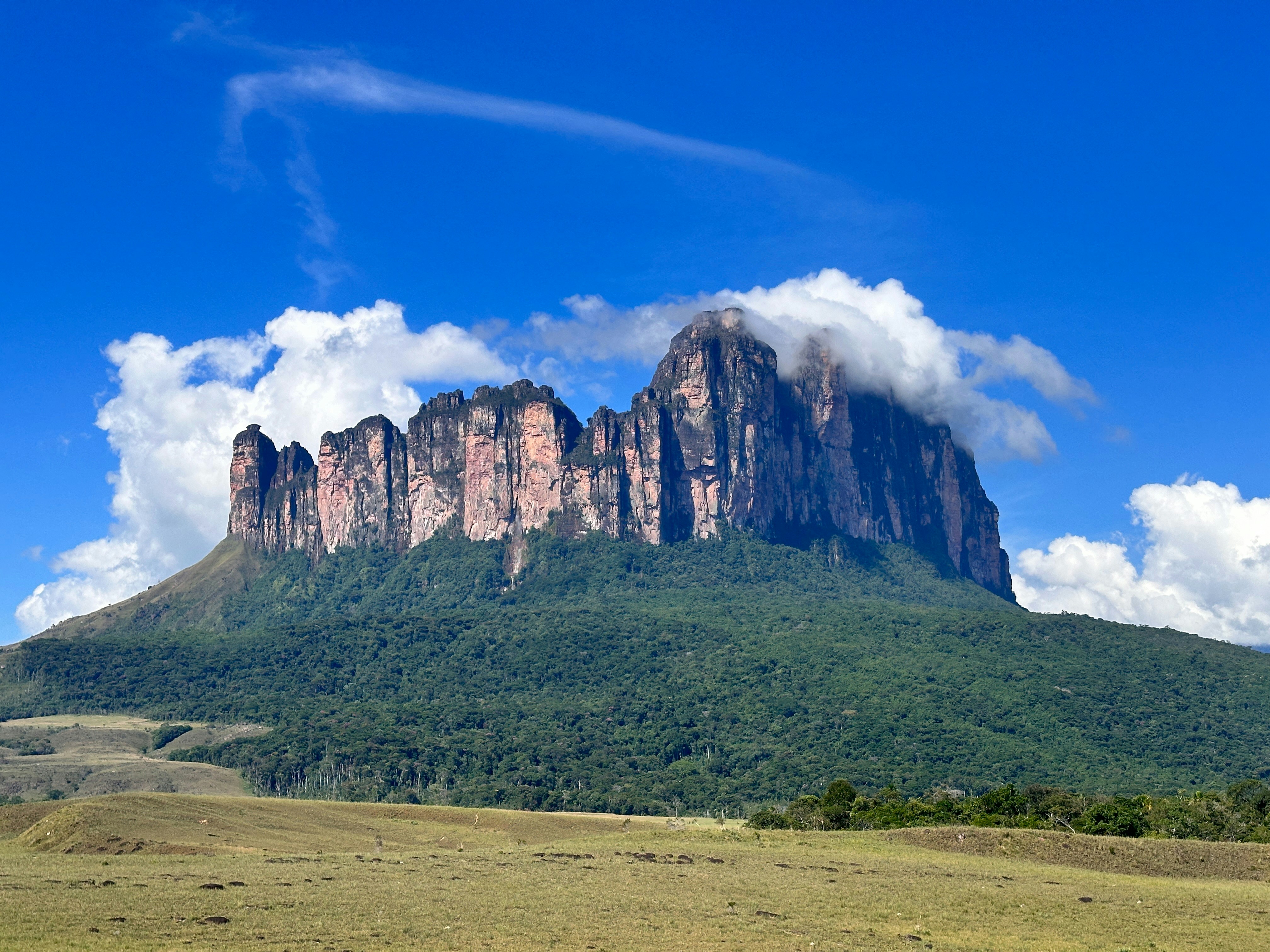 A massive, flat-topped mountain rises under blue skies.