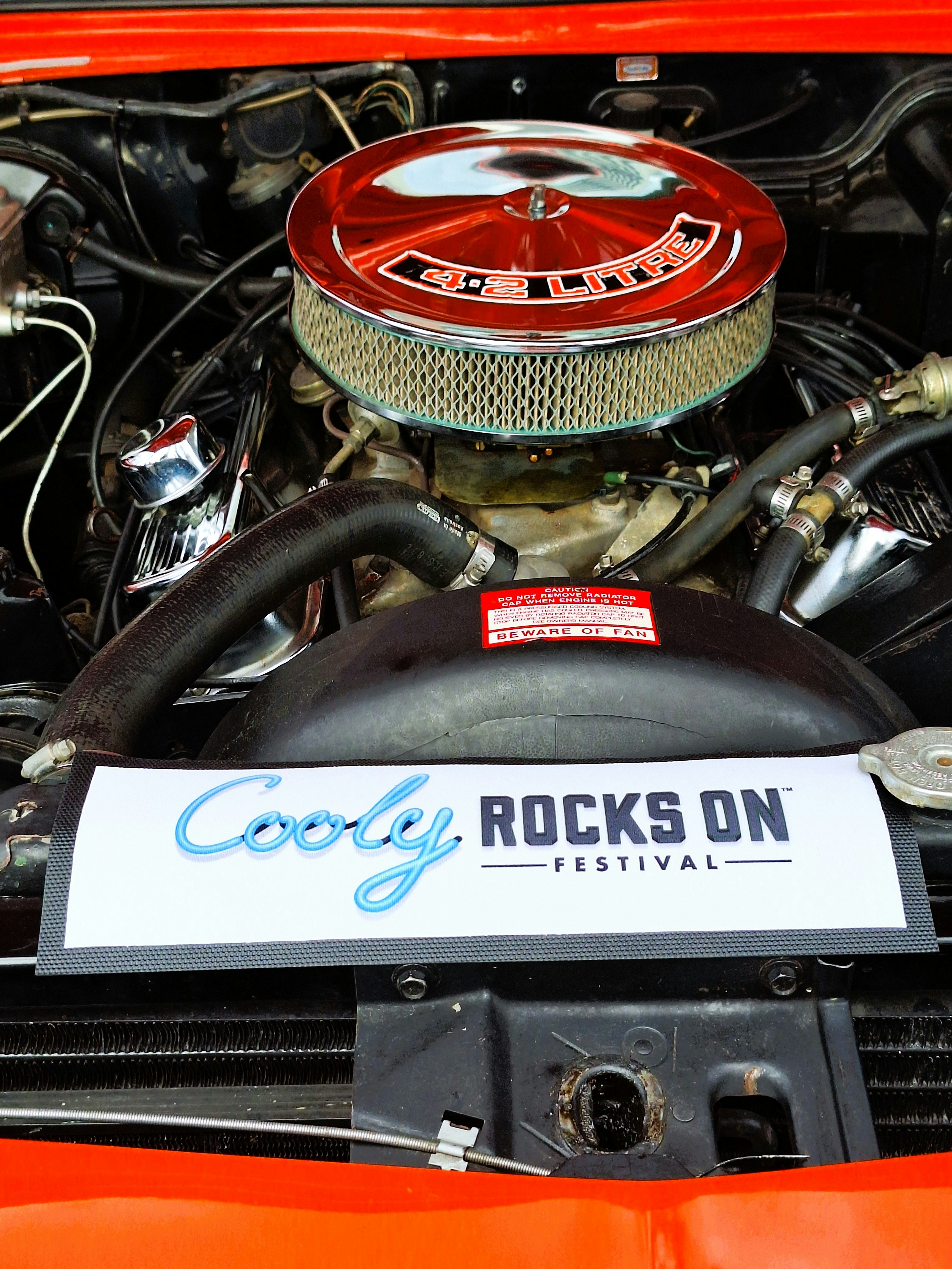 A classic car's engine is on display.