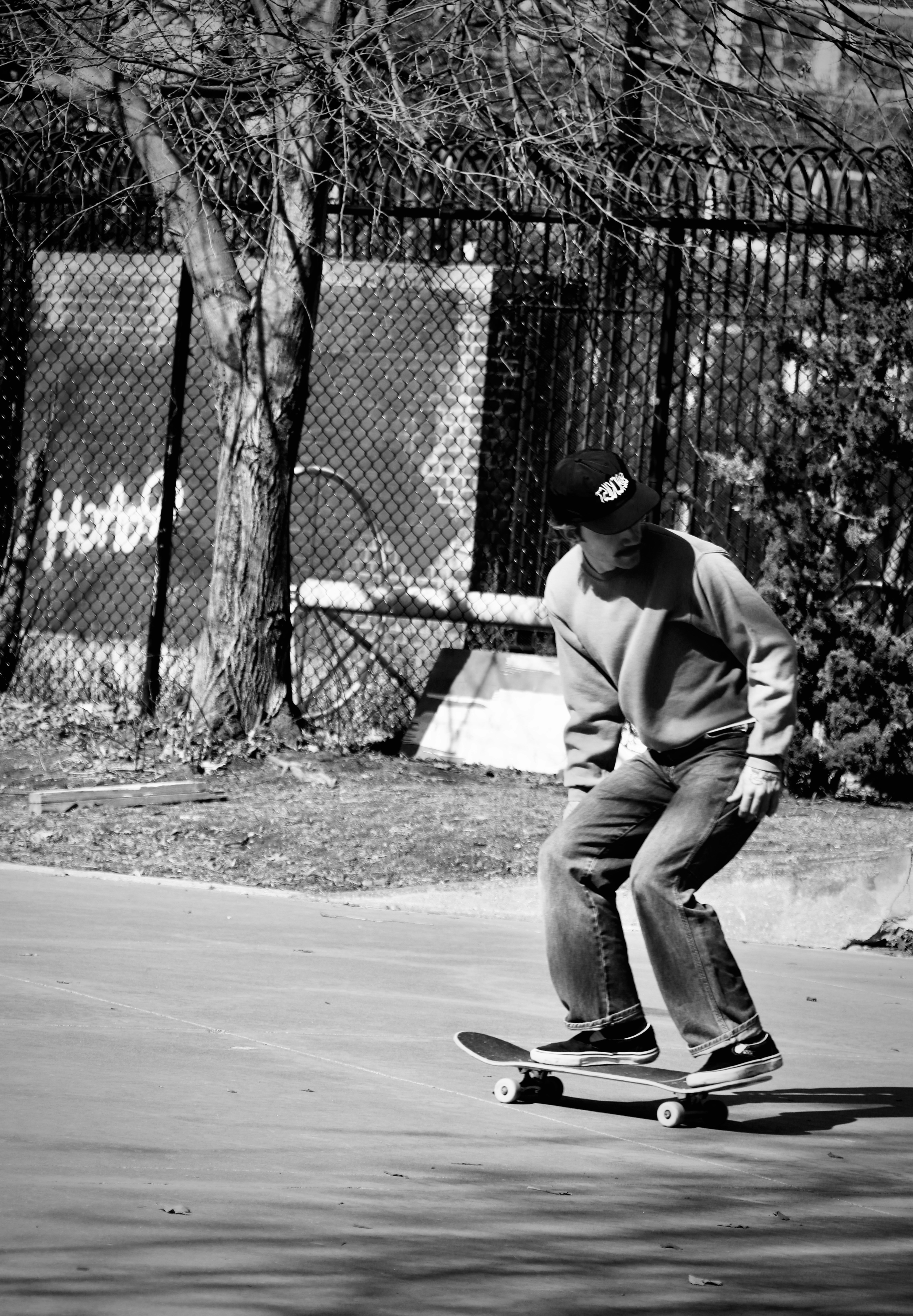 A skateboarder rides along a pathway.