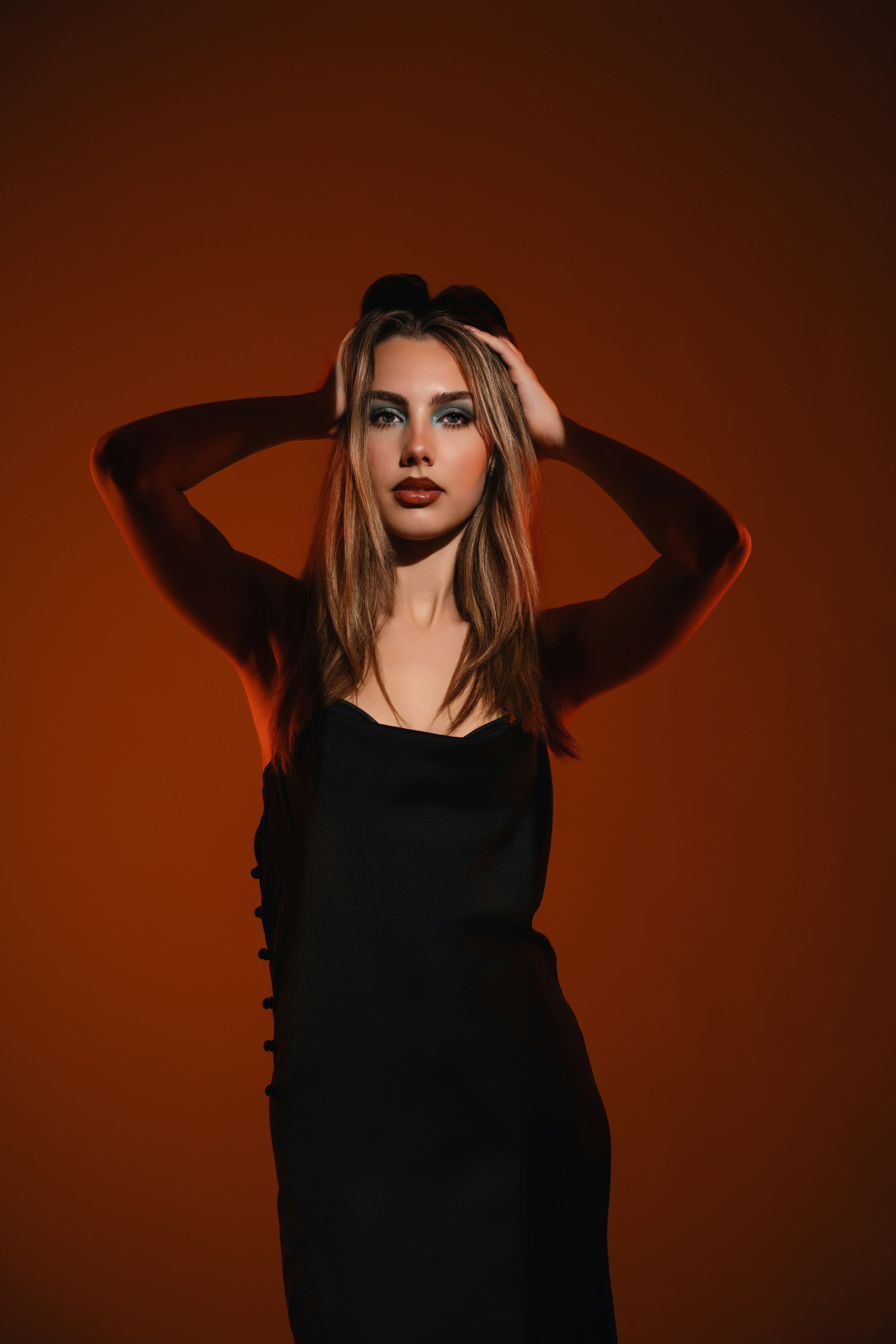A woman poses in a black dress. photo – Free Female model Image on Unsplash
