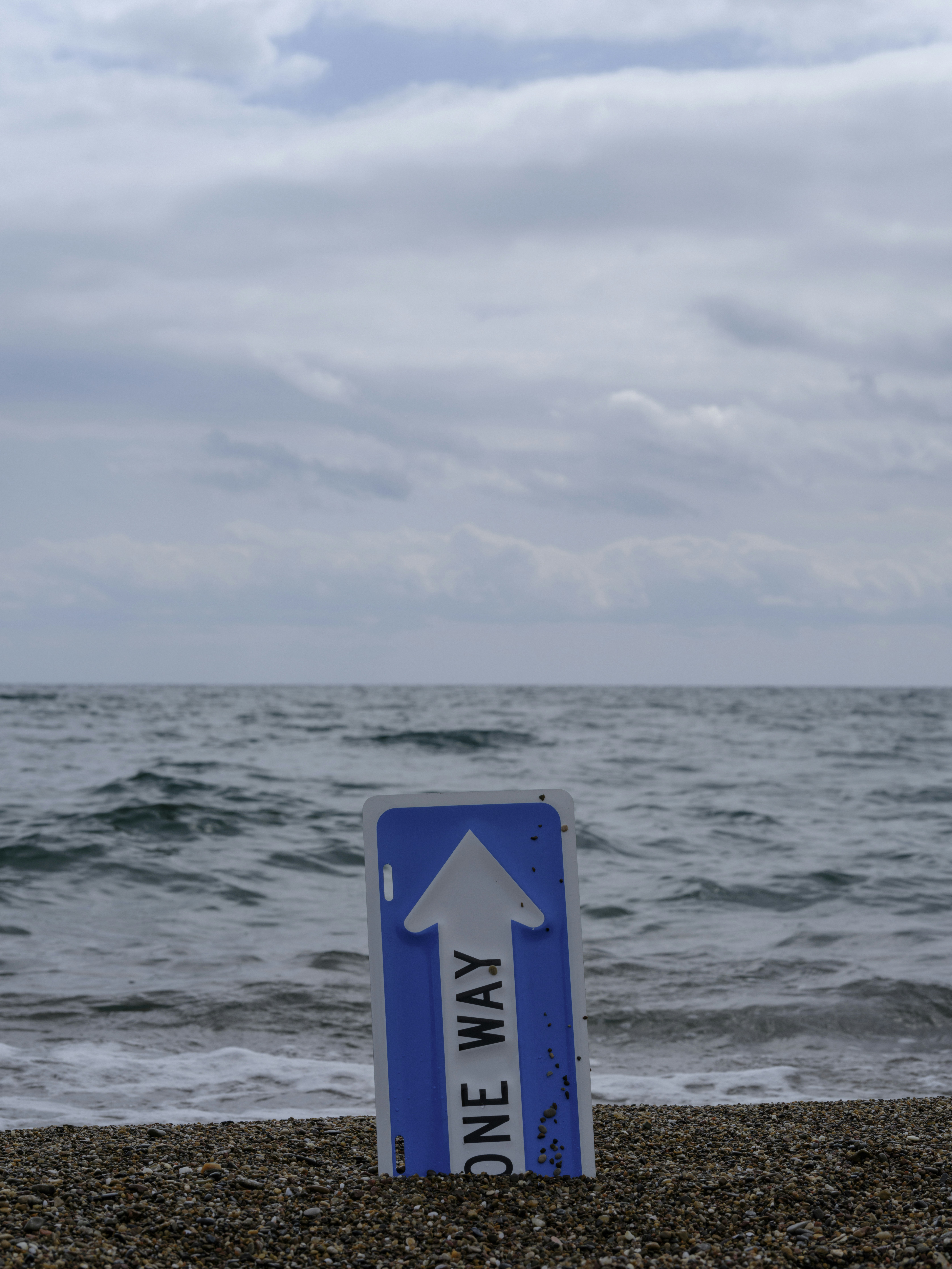 A "one way" sign on the beach faces the ocean. photo – Free Background ...