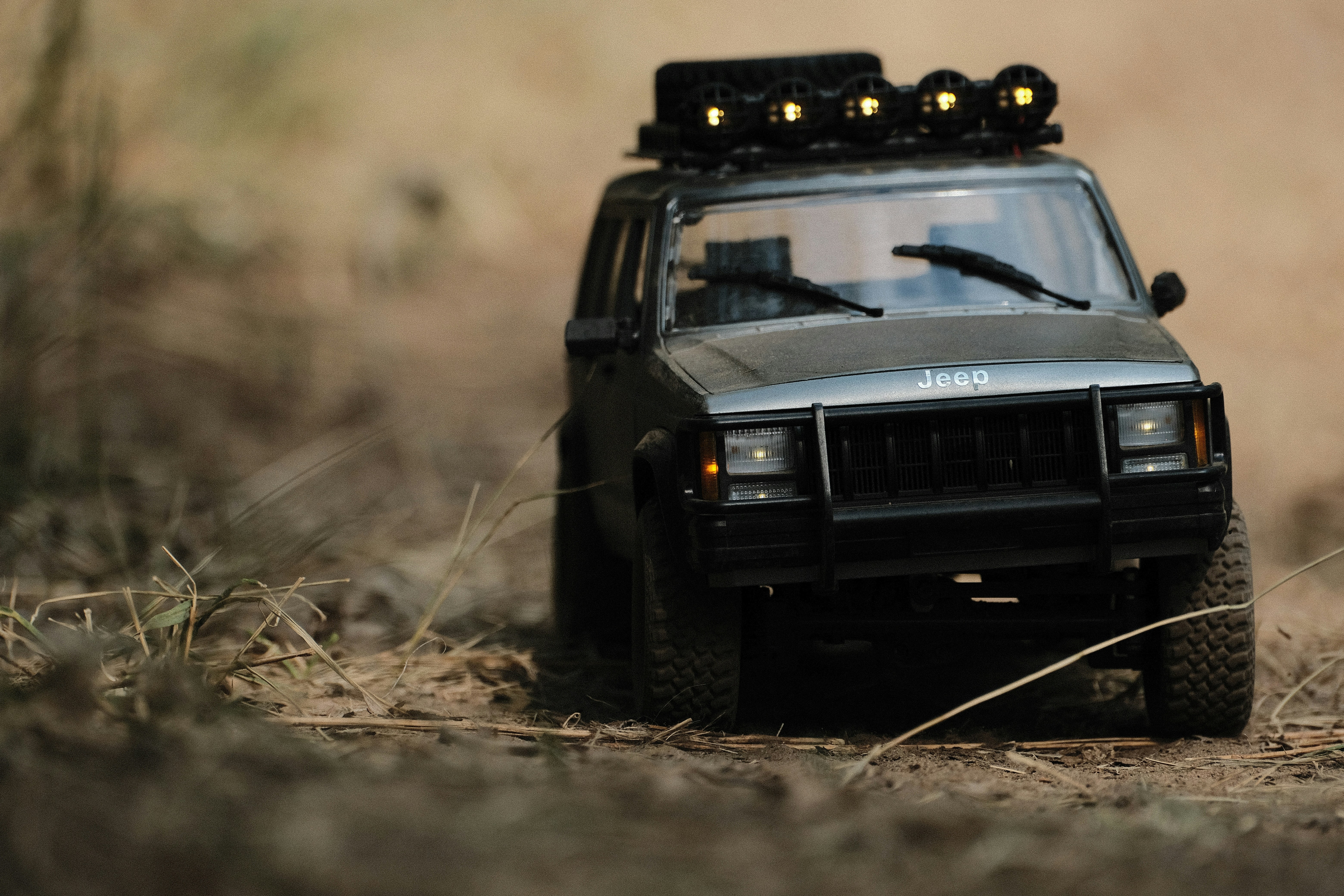 Dust-Lit Frontier: A Rugged Jeep on a Narrow Off-Road Trail