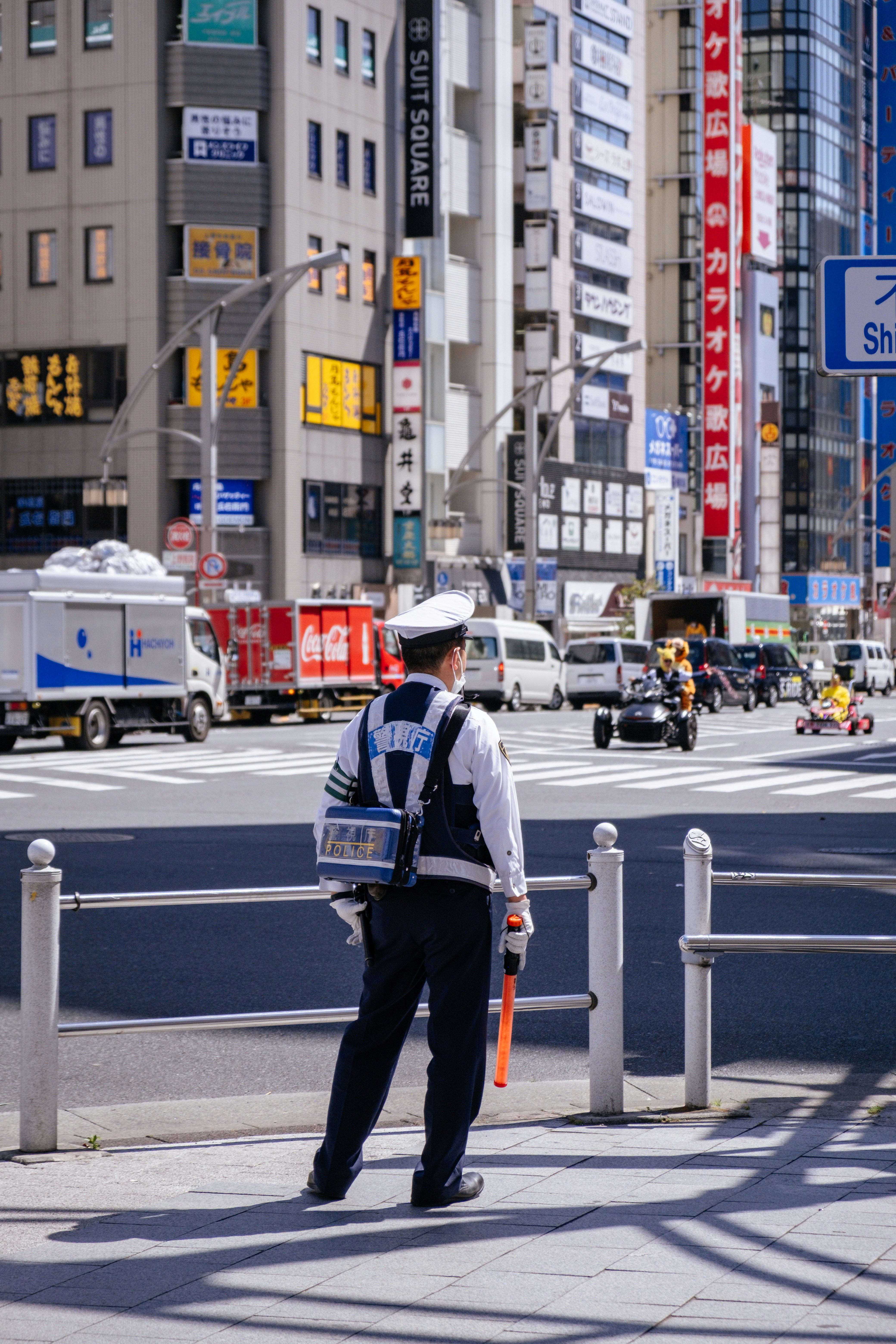 A police officer directs traffic in a busy city.