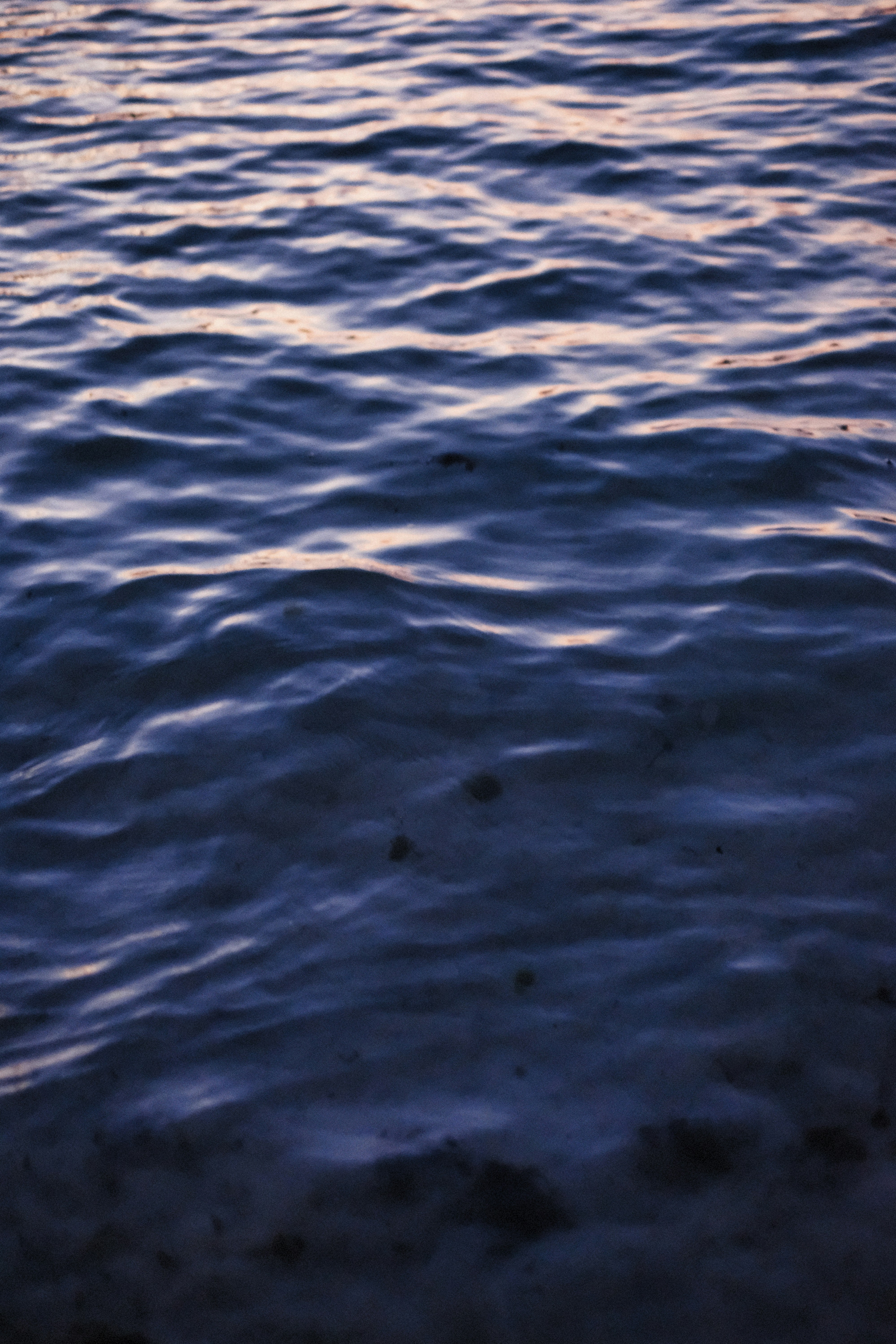 Dark blue water with small waves.