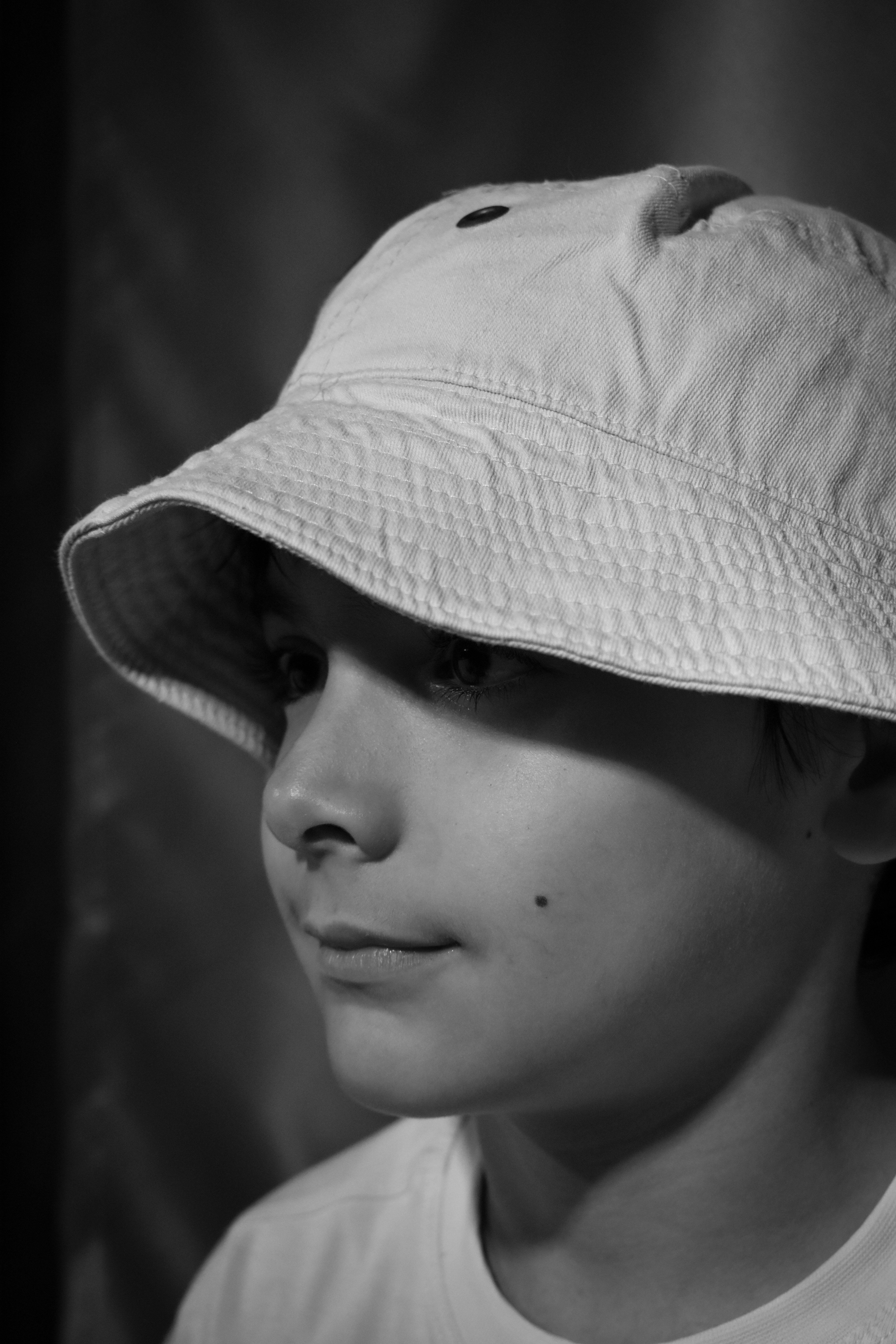 Under a Gentle Brim: A Quiet Monochrome Portrait