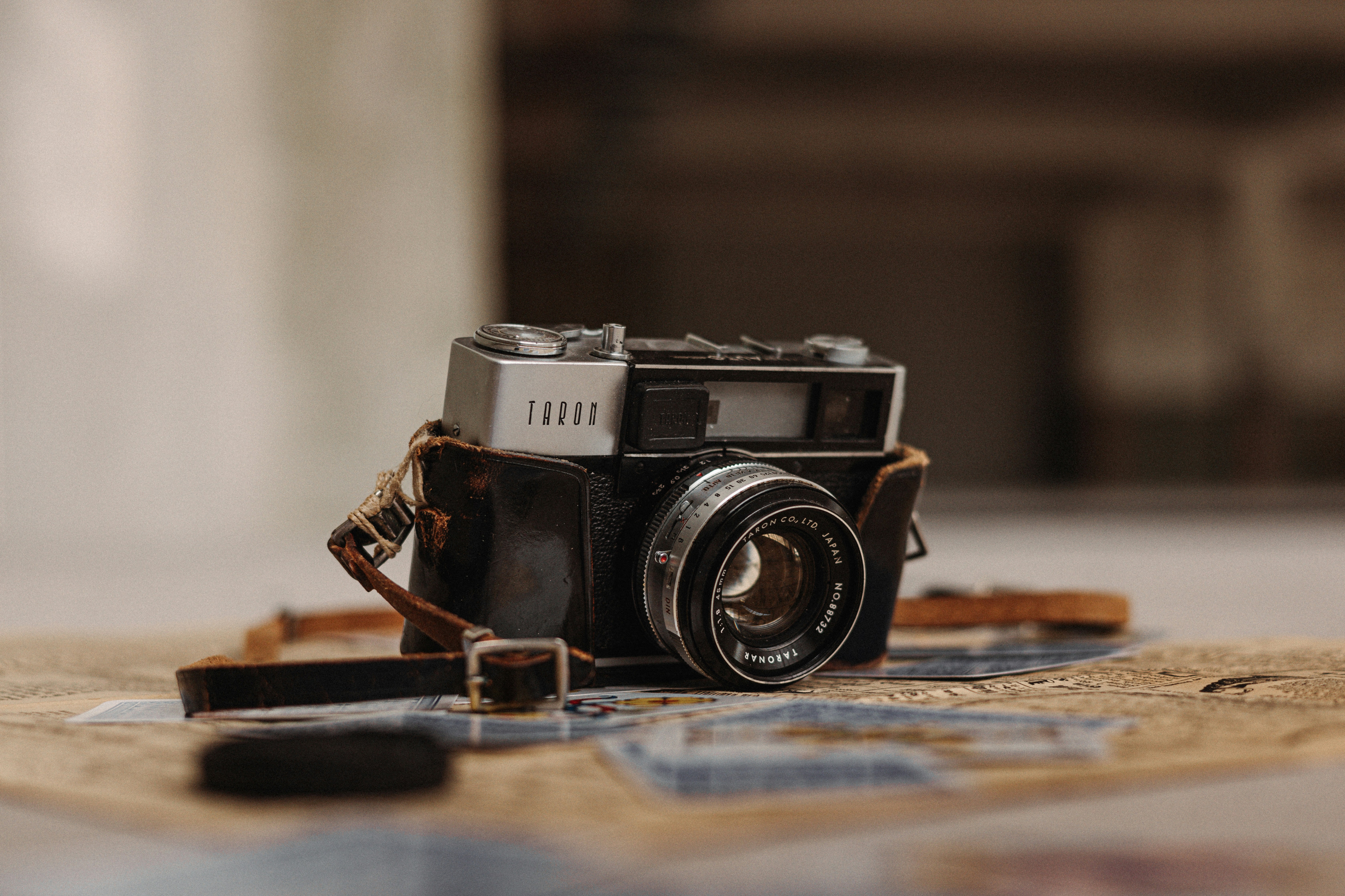 A vintage camera rests on a detailed map.