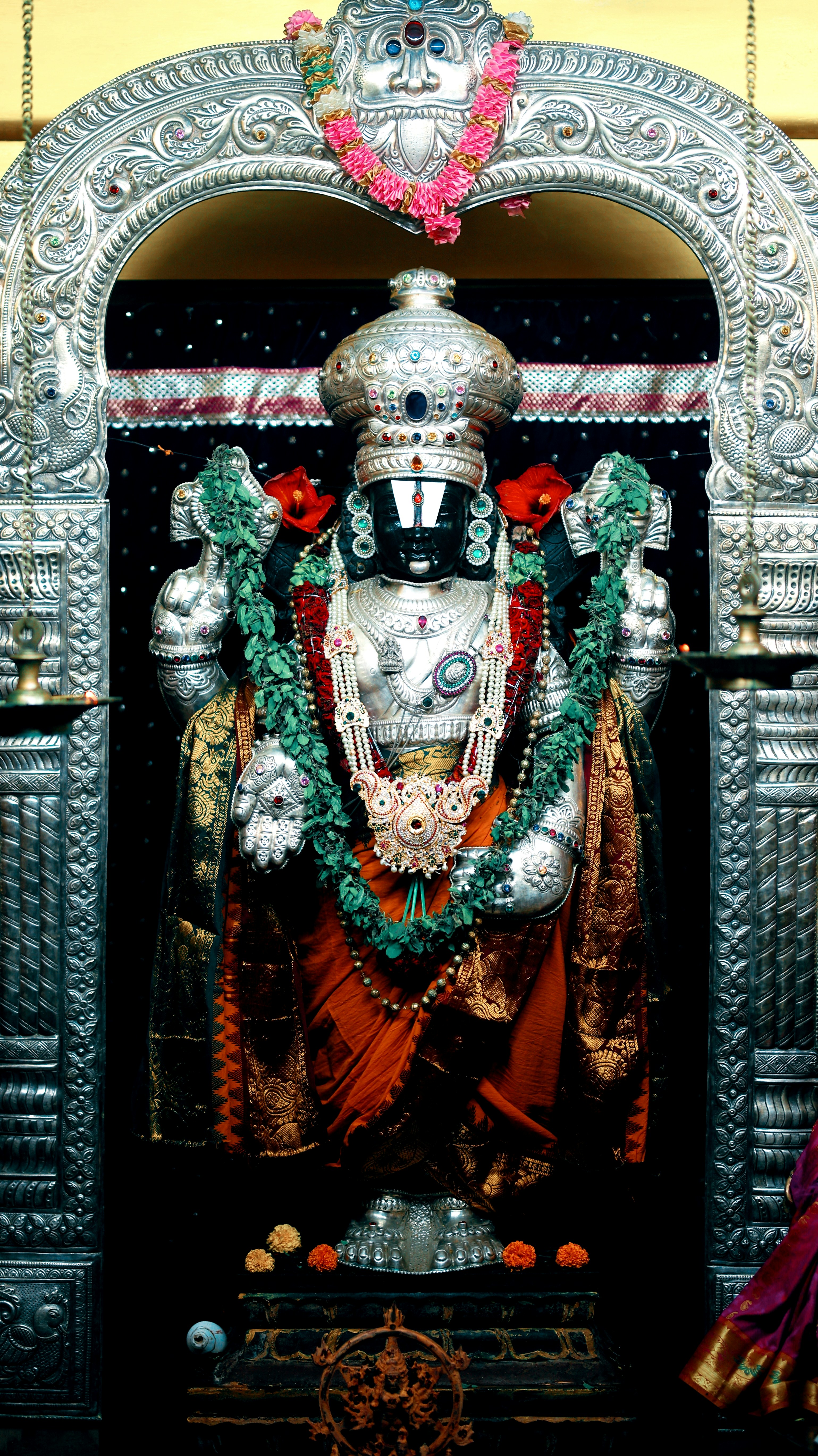 A statue of an indian deity, intricately adorned.