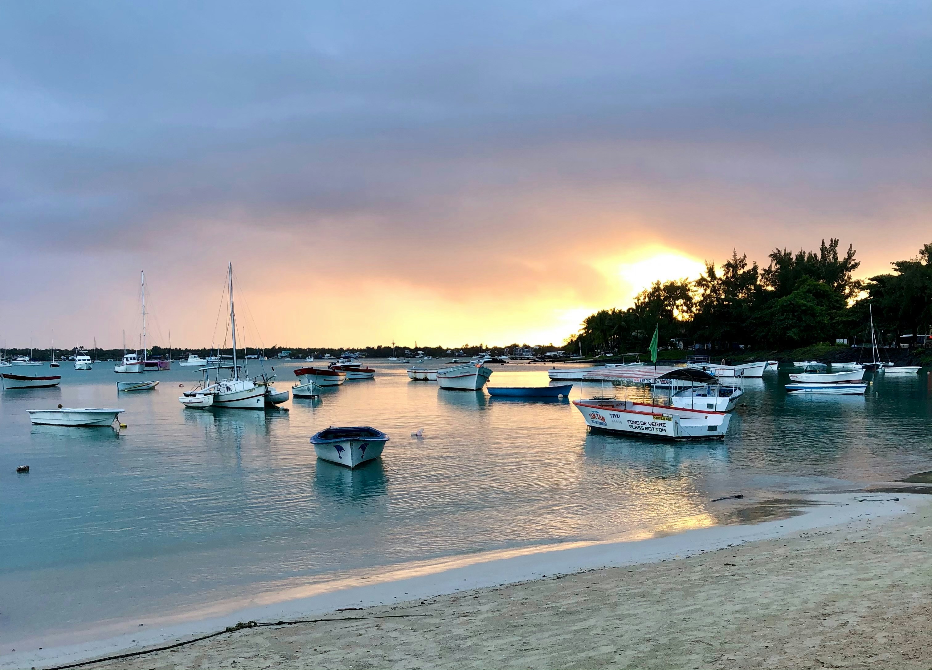 Harbor at Dusk: Boats Rest Beneath a Golden Horizon