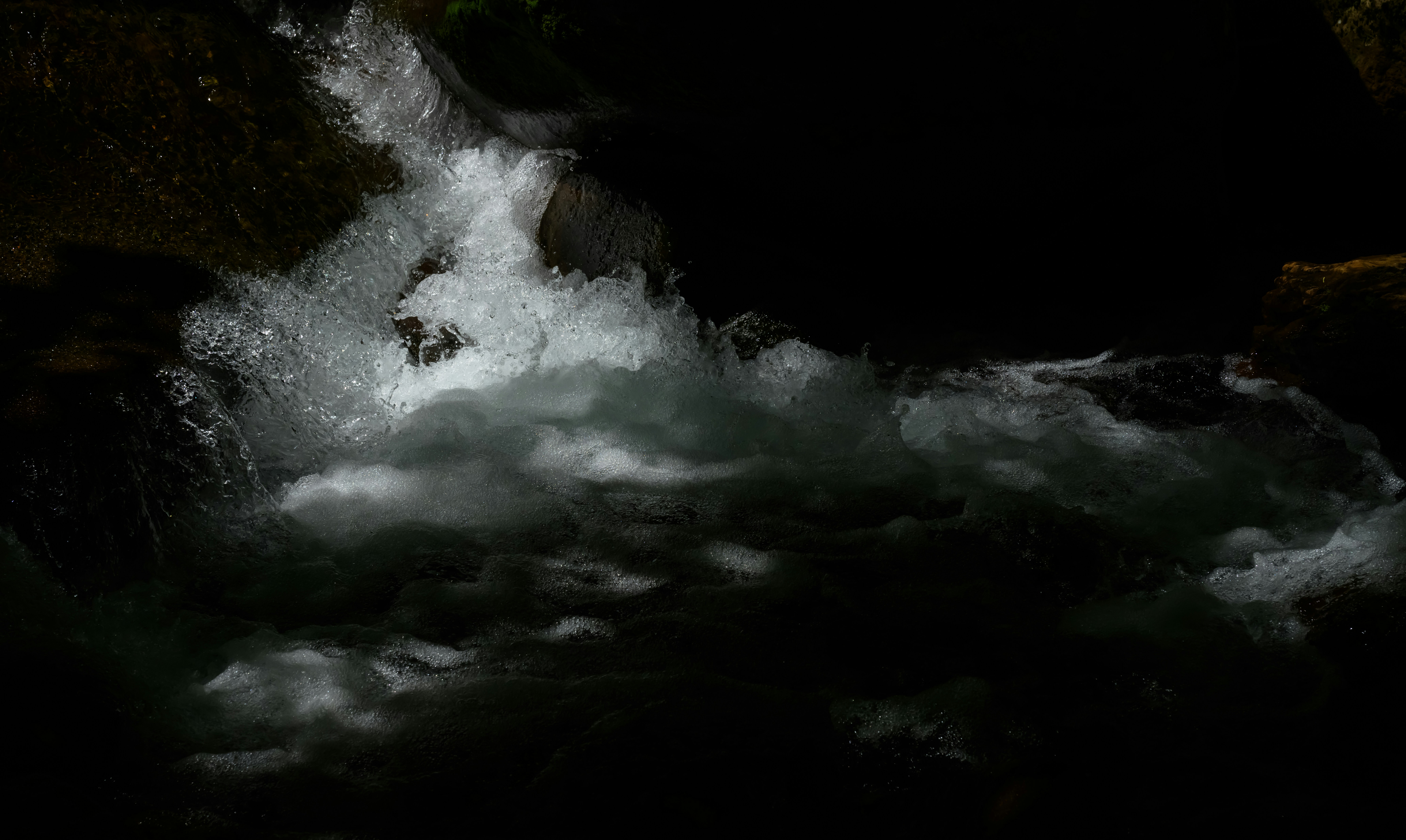 Rushing water cascading over rocks and through shadows. photo – Free ...