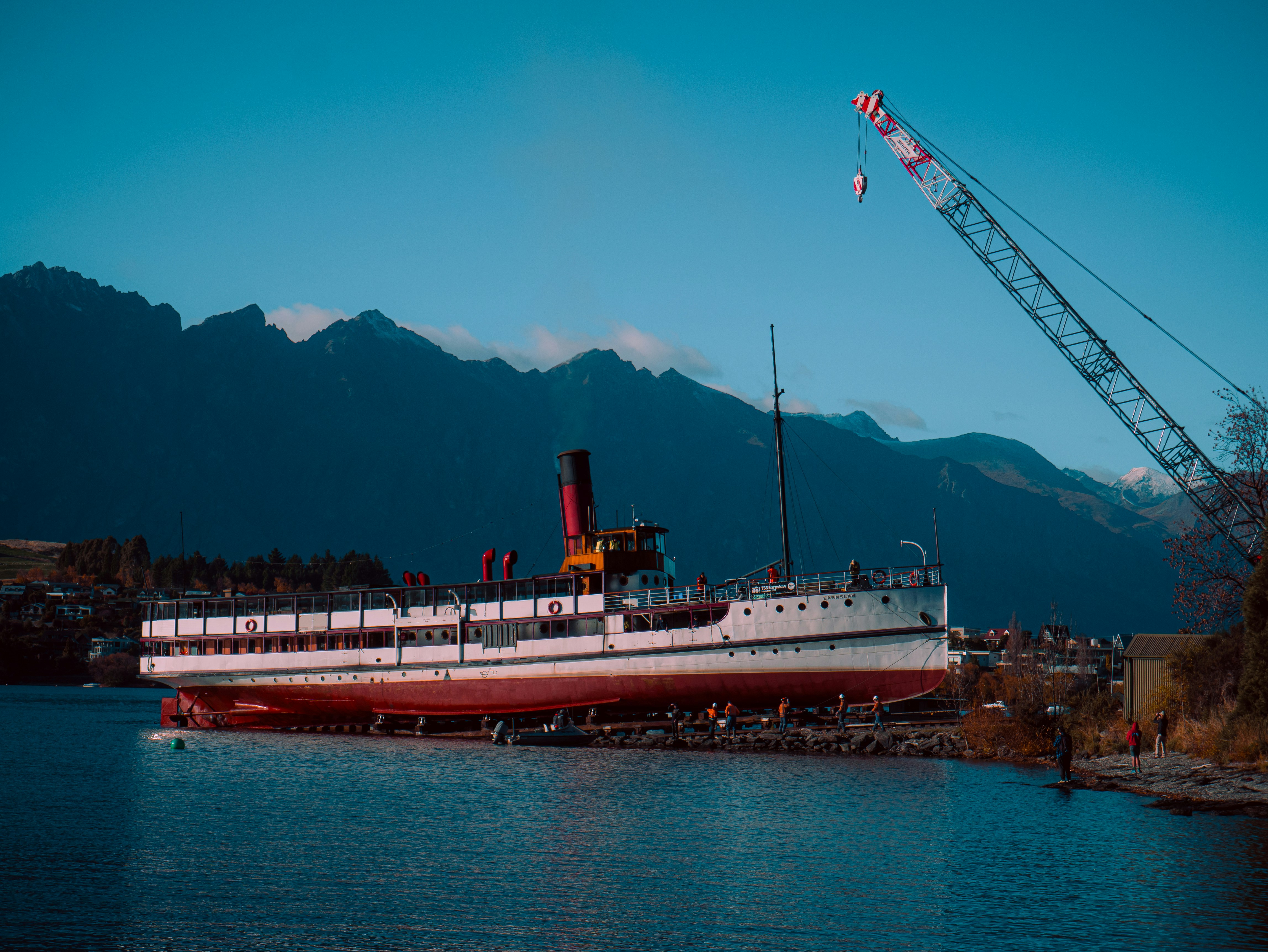Steamship at Docks Under a Mountain Range with Crane