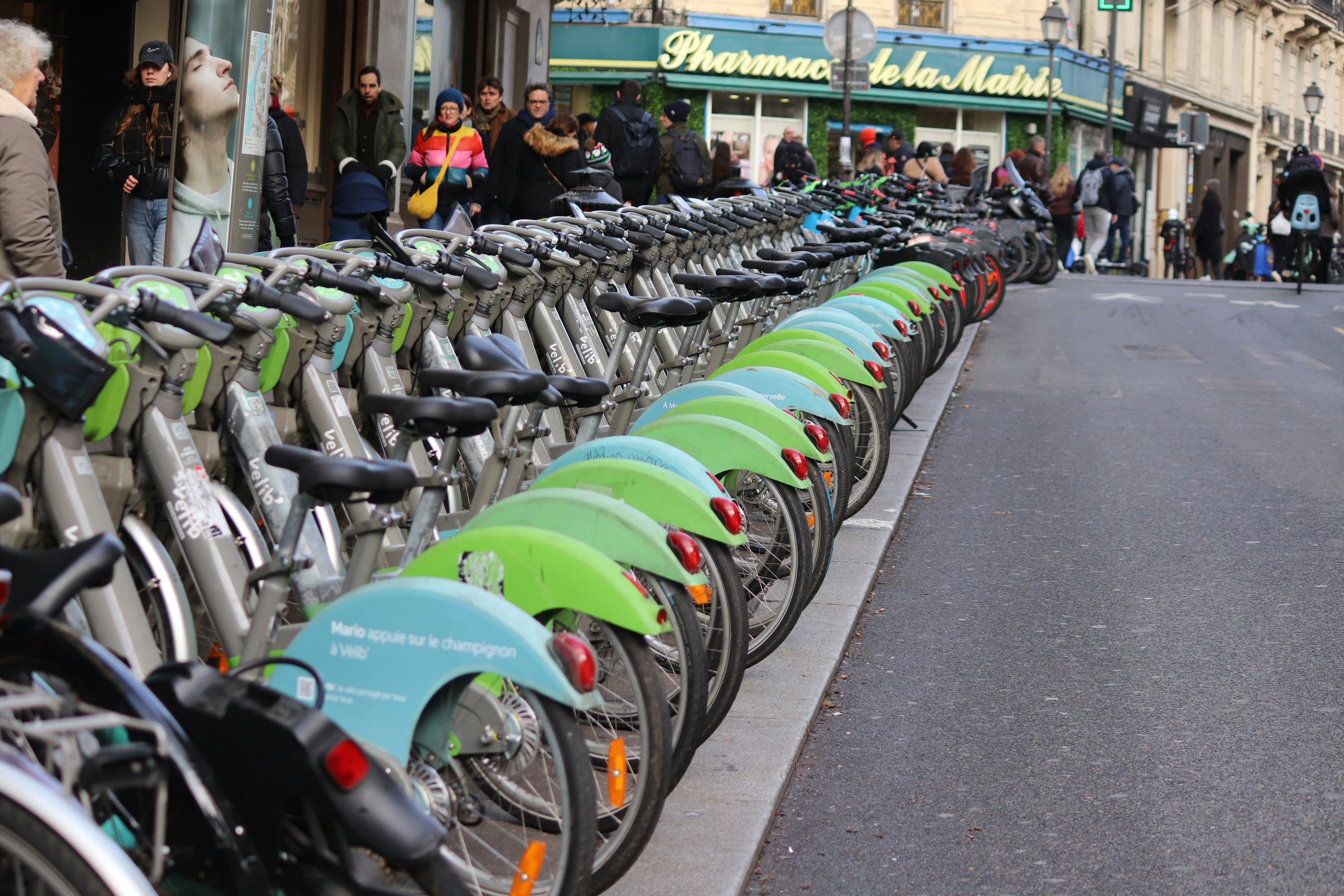 Green Fleet Along a Paris Boulevard: A Quiet Parade of Shared Bicycles