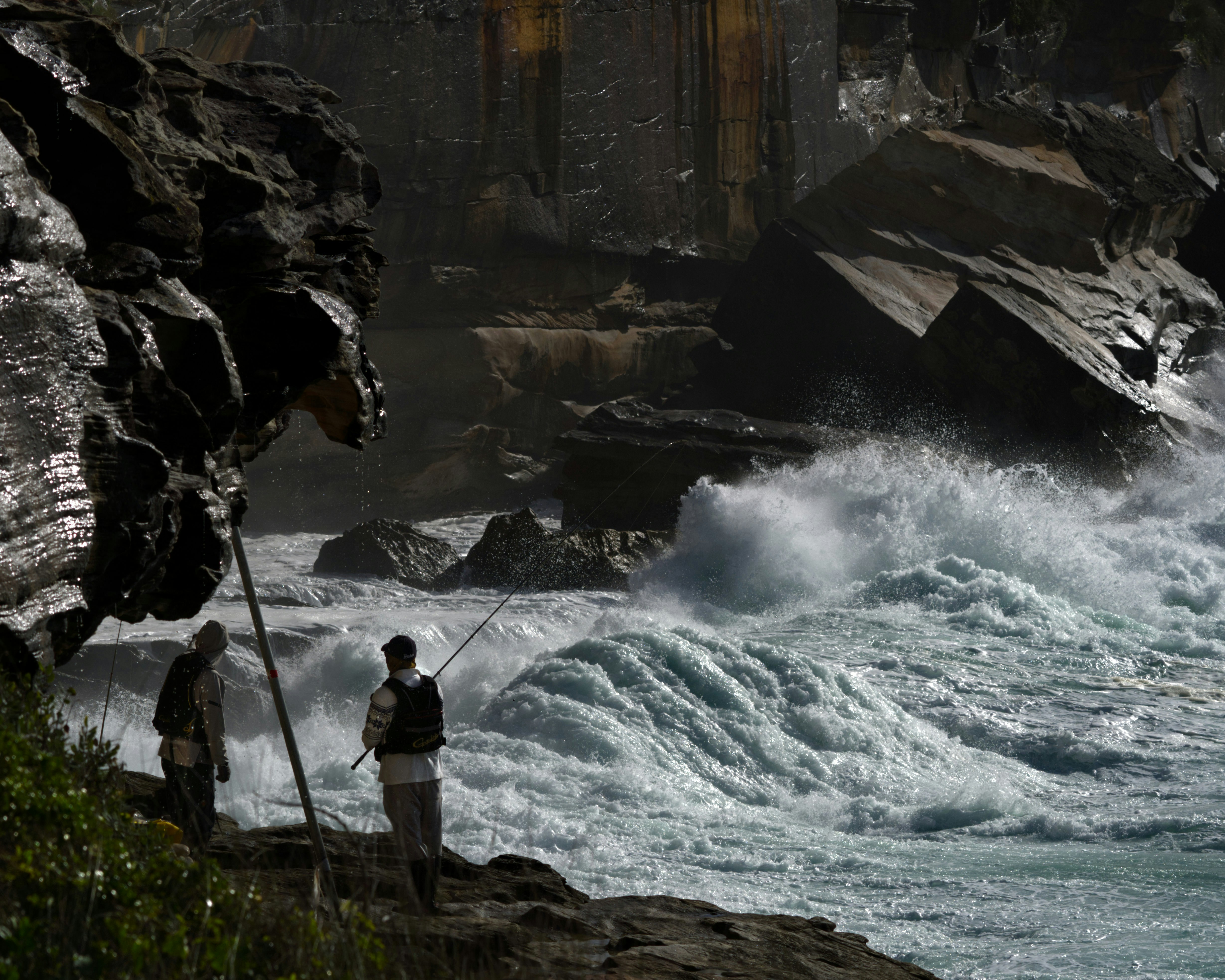 Edge of the Breakers: Two Figures Beside Roiling Sea and Dark Basalt Cliffs