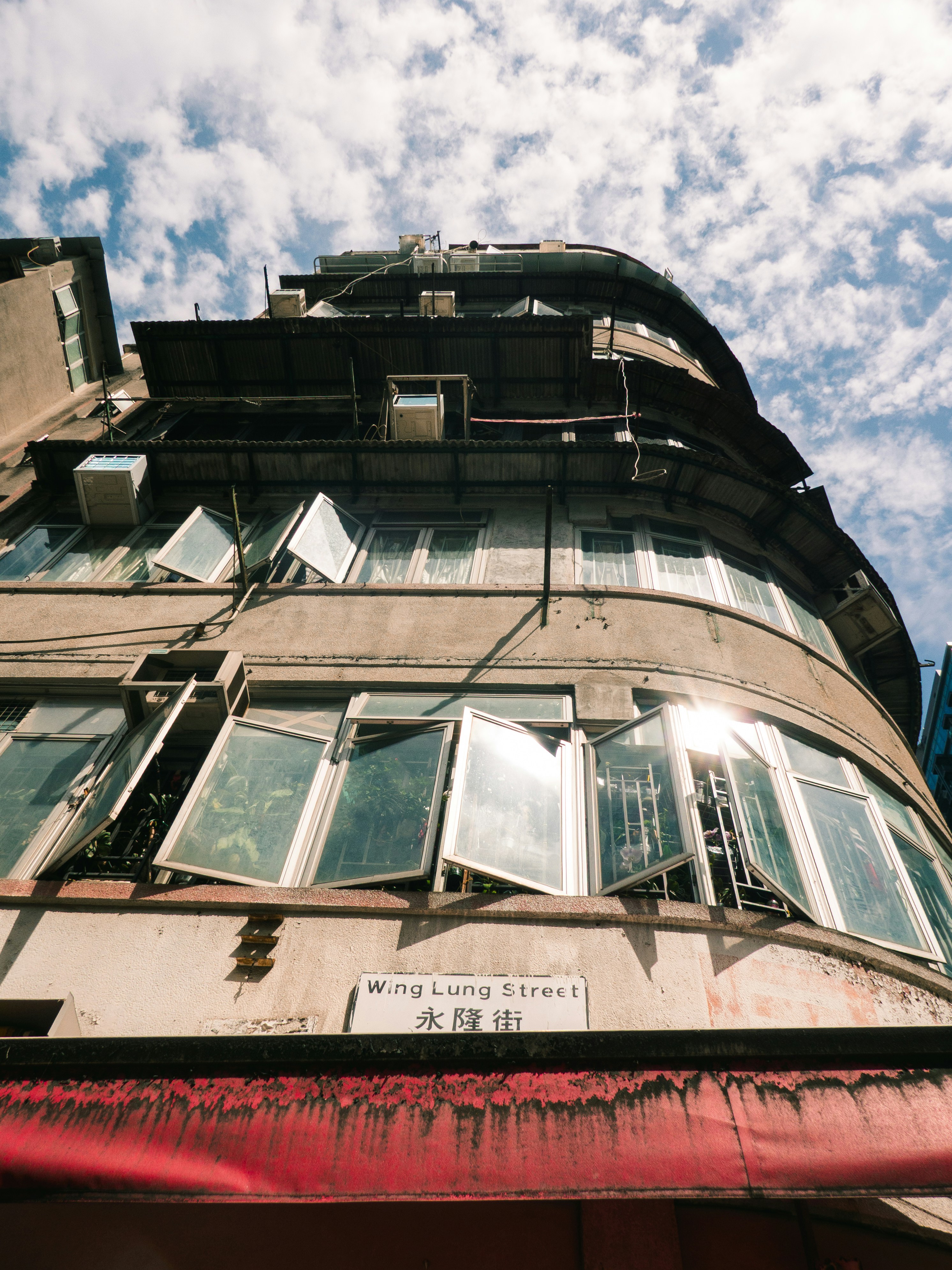 Corner Facade with Tilted Windows Under a Bright Sky