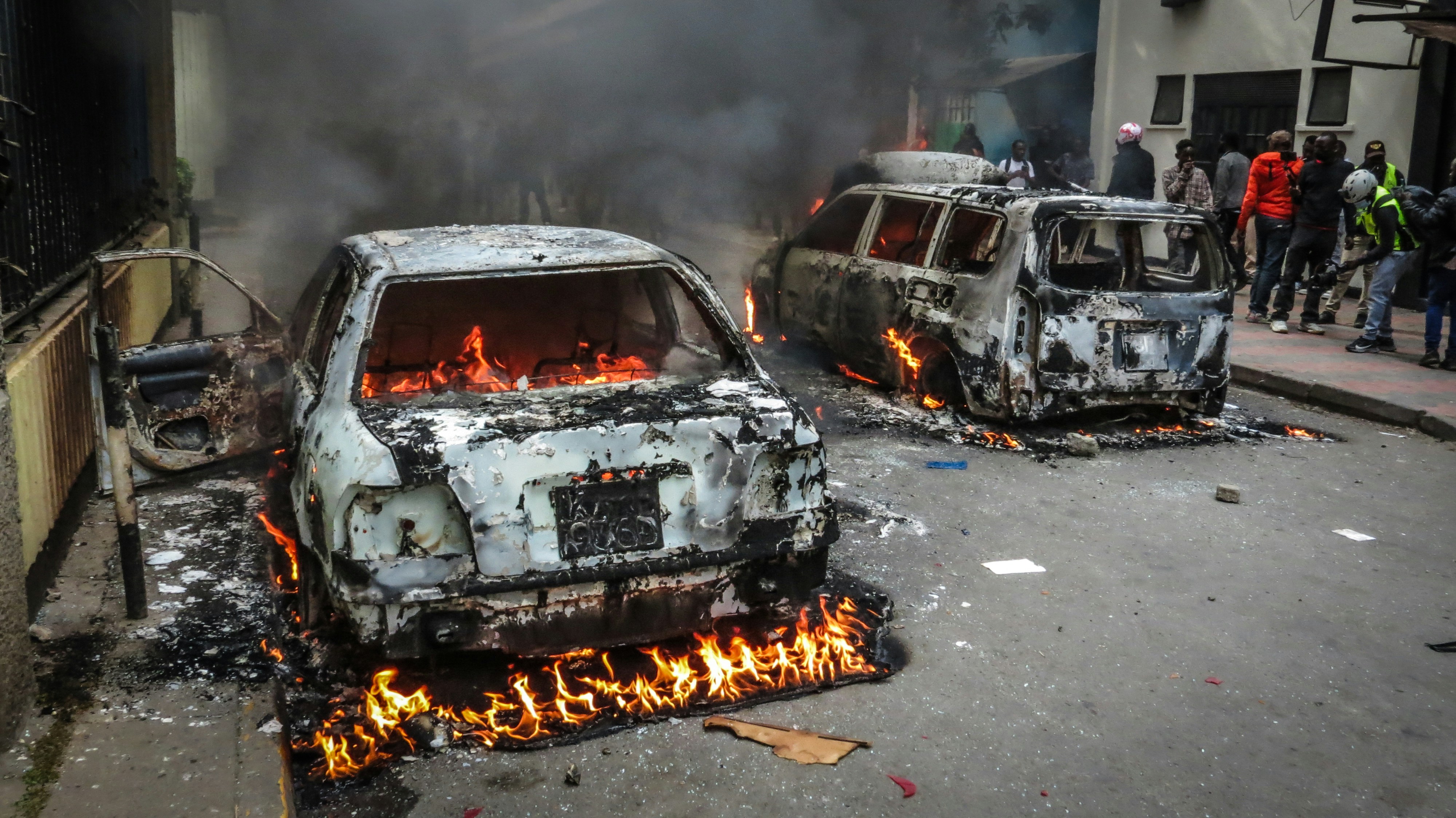 Cars on fire during the protest for #JusticeForAlbertOjwang.