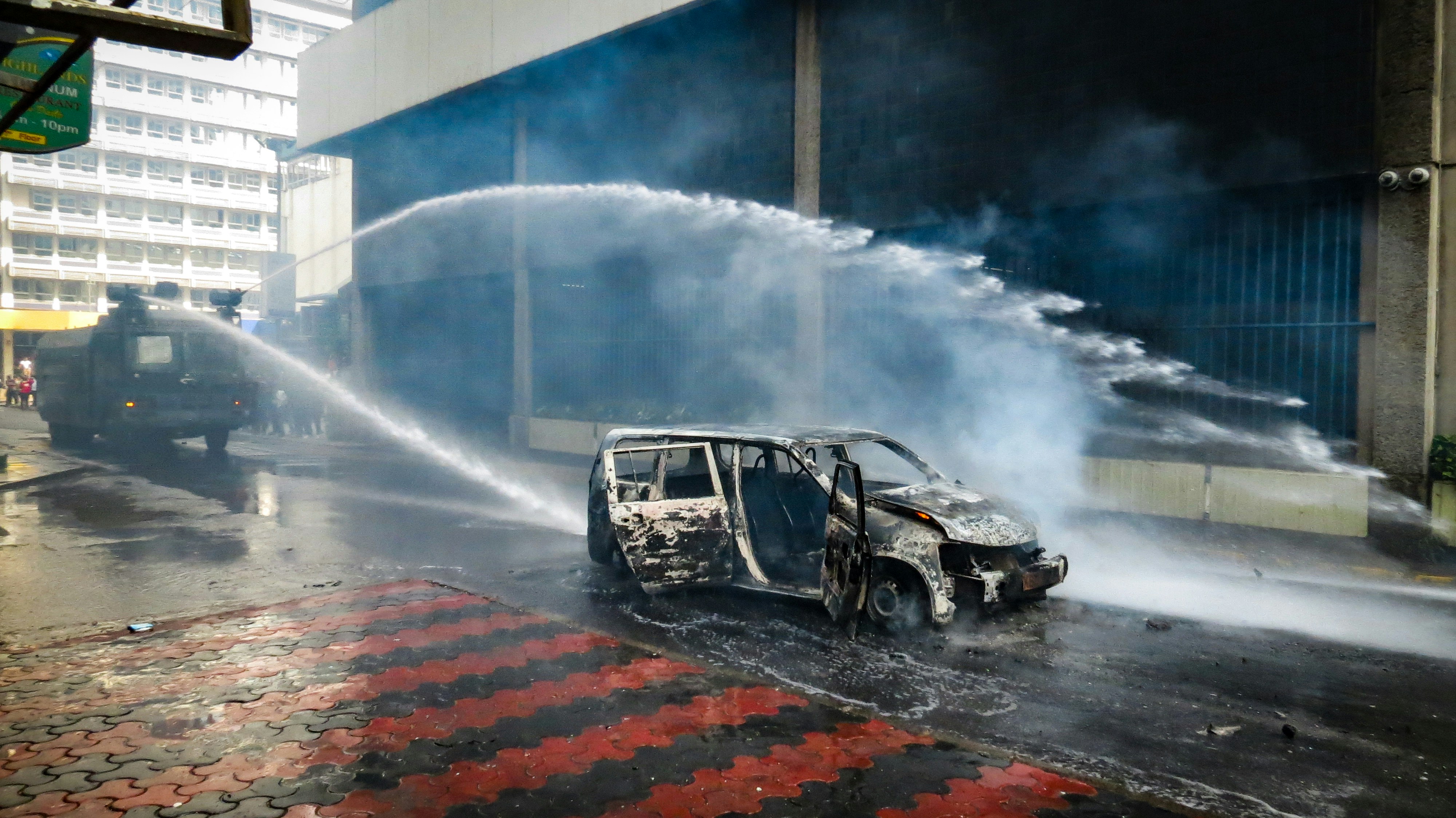 A firetruck extinguishes a burning vehicle with water. photo – Free Car ...