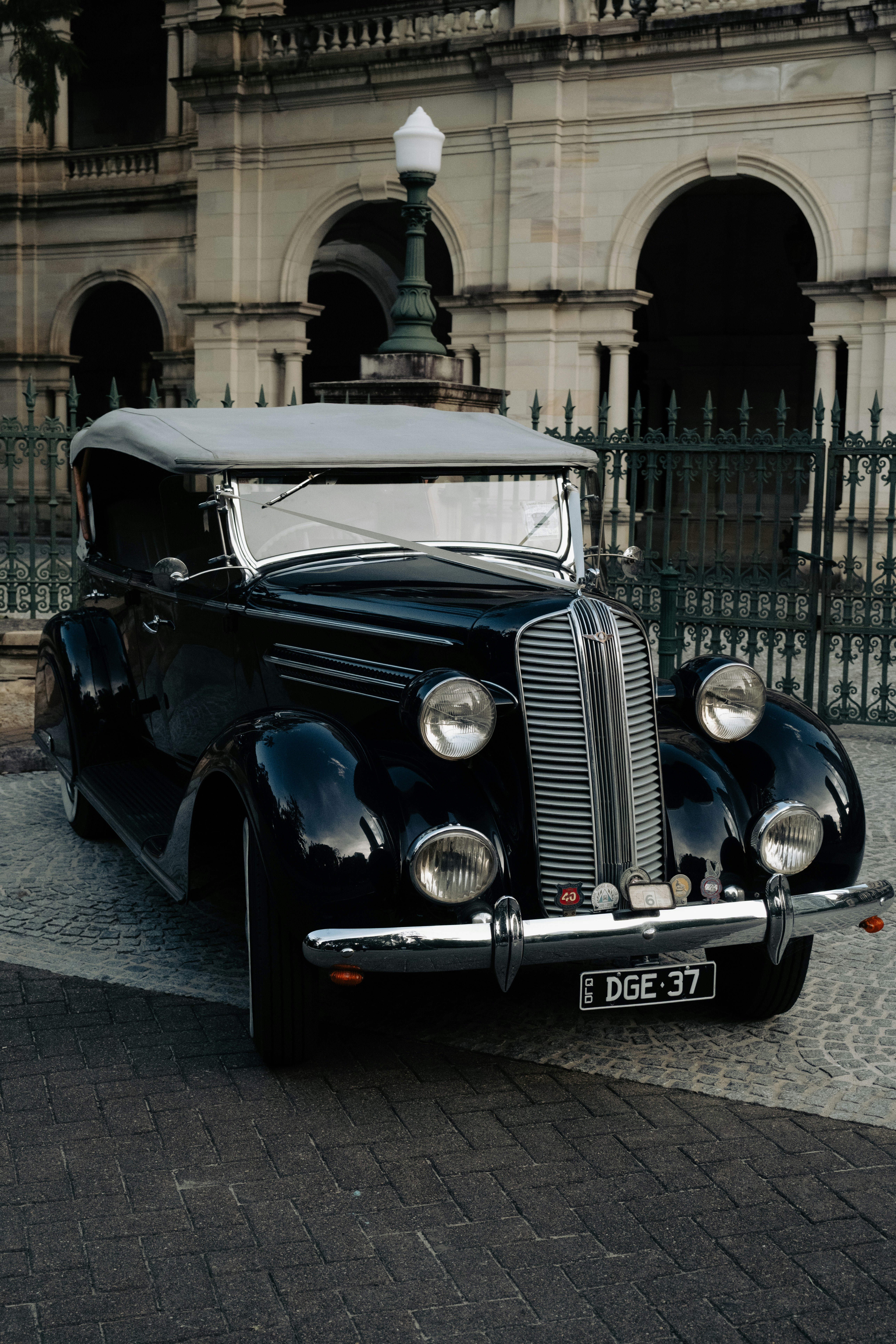 Midnight Drive: A Classic Car Pause by the Historic Facade