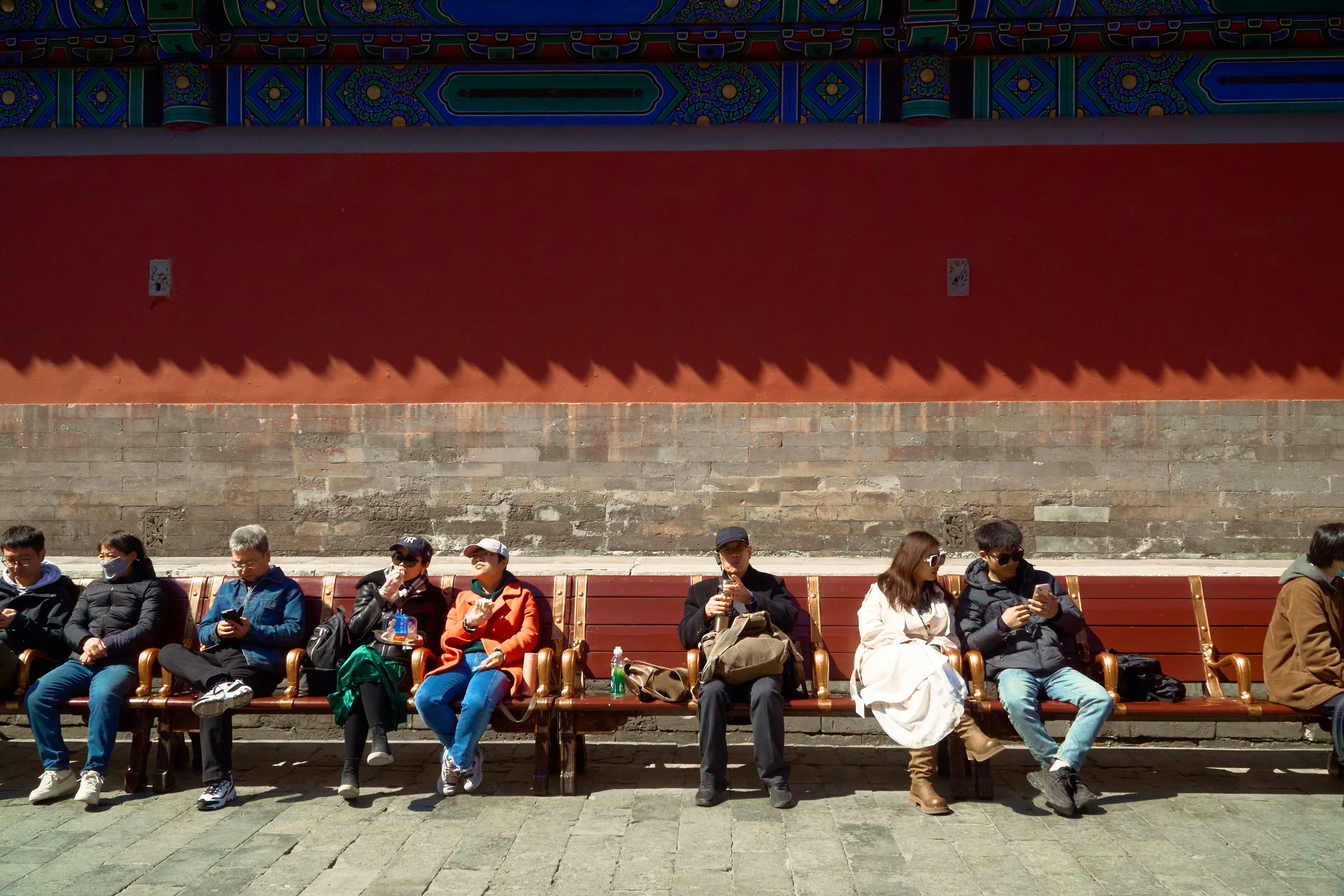 Crimson Wall, Quiet Bench: Travelers Rest in Afternoon Light