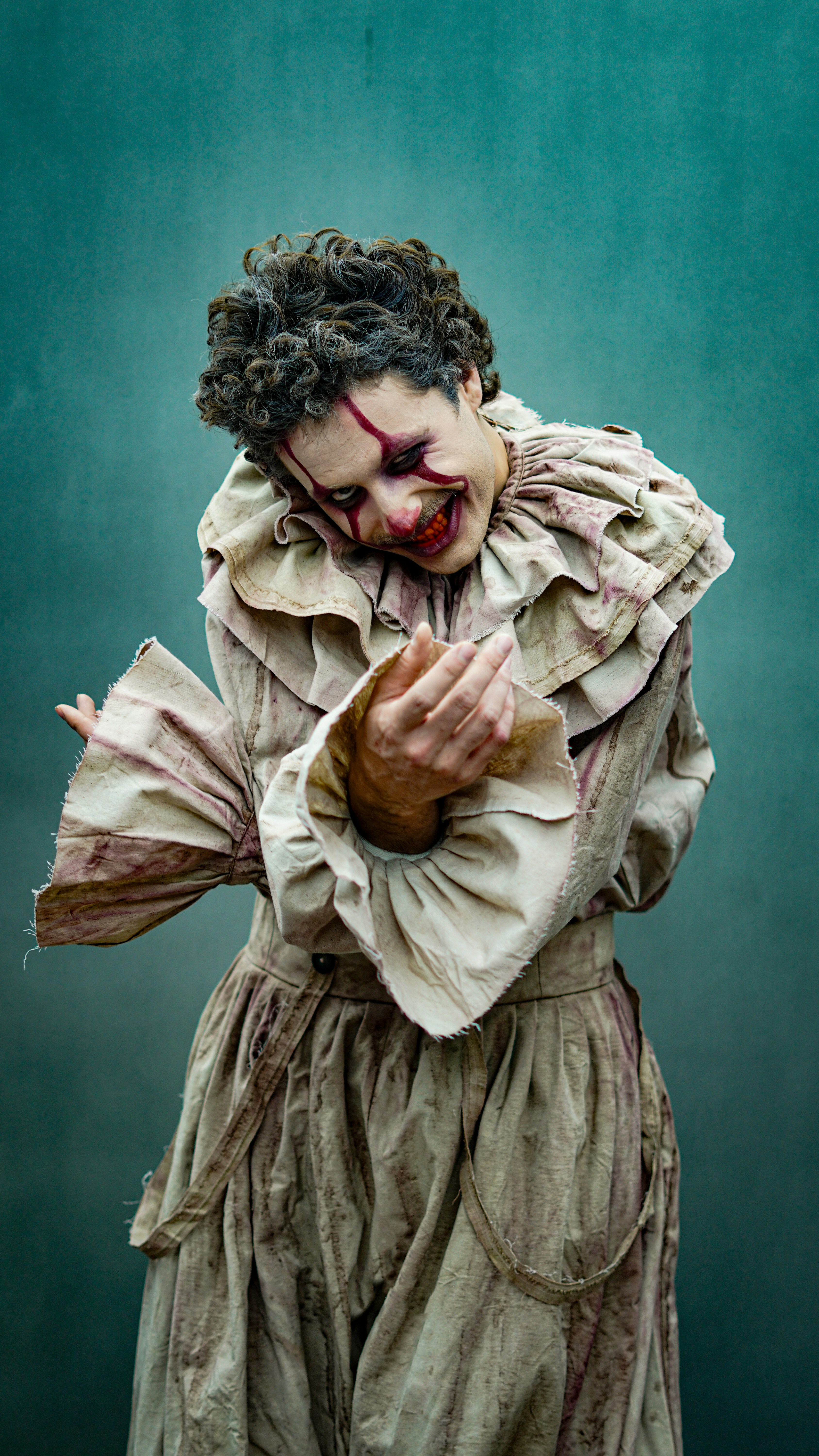 Clown in Weathered Costume Finds a Quiet Moment